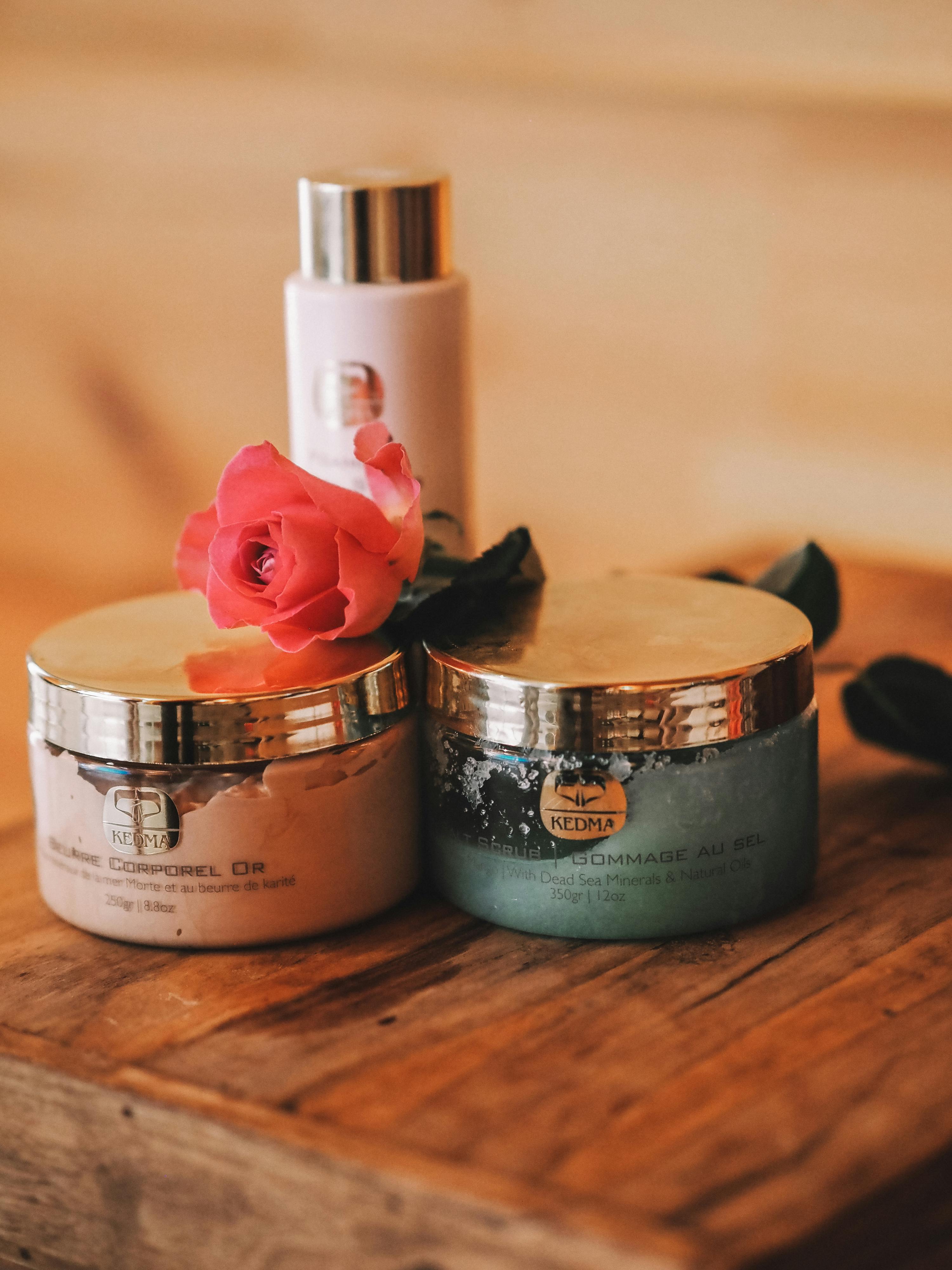 A jar of face masks and a rose on a wooden table · Free Stock Photo