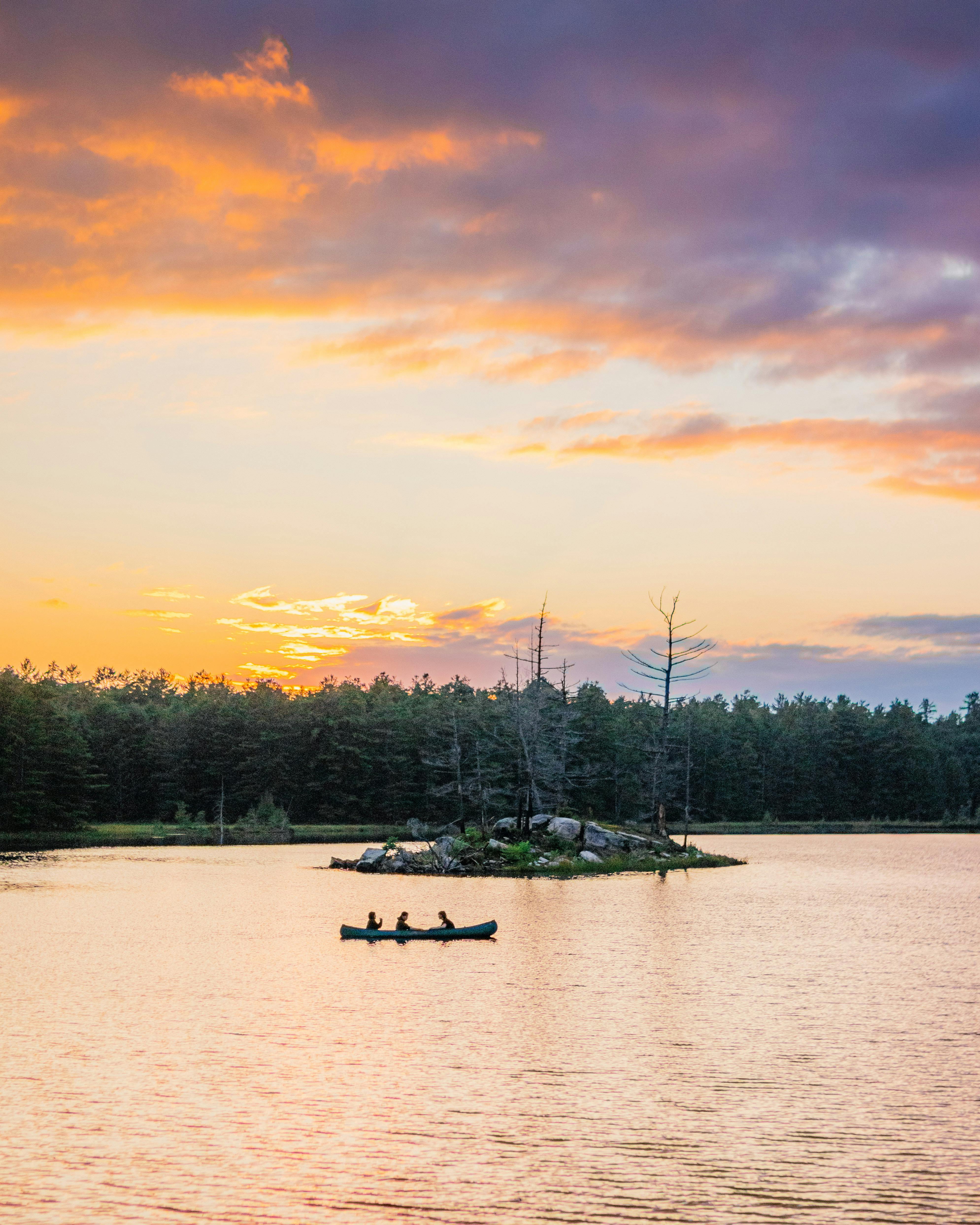 Canoe on Lake at Dusk · Free Stock Photo