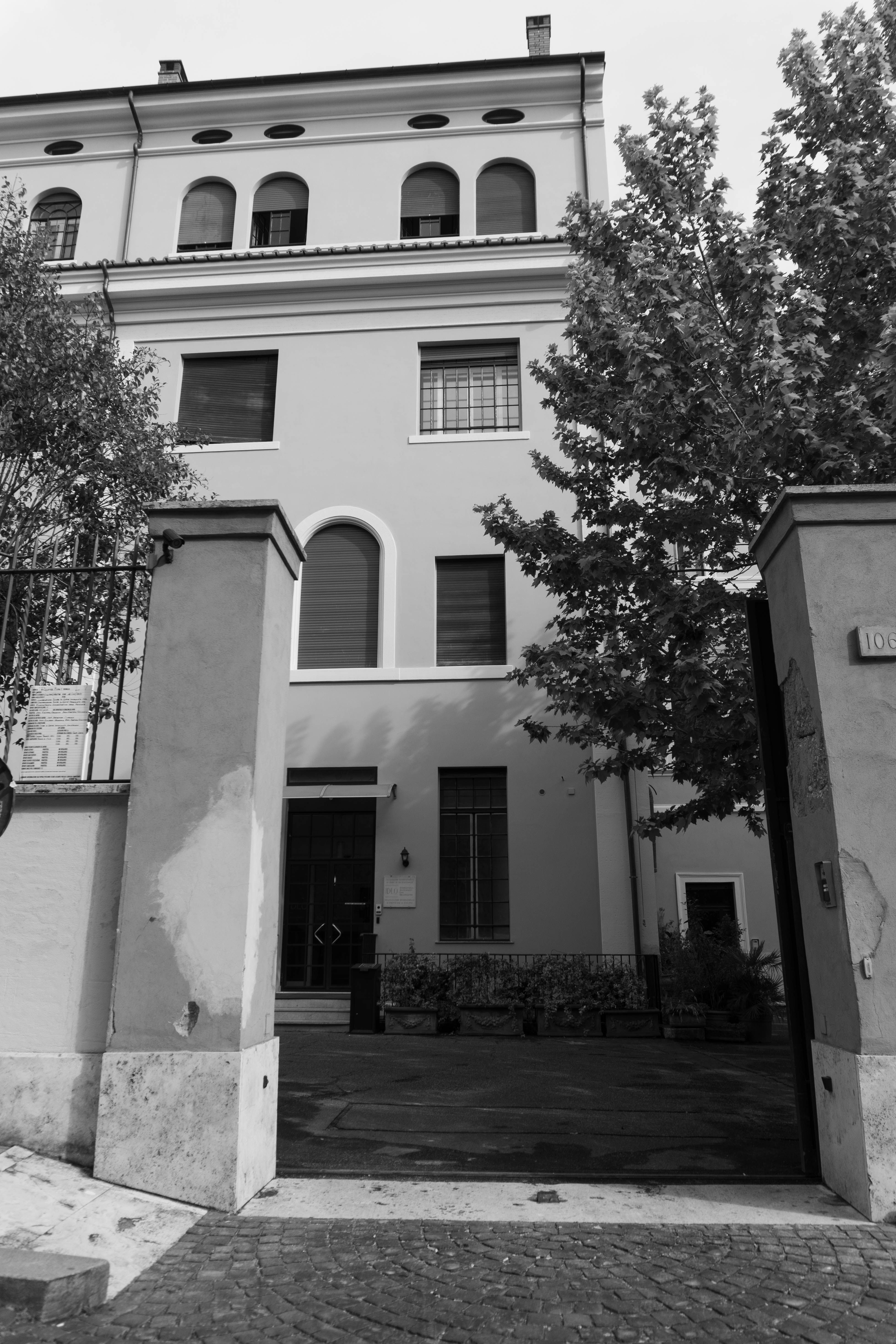 Building behind Gate in Black and White · Free Stock Photo
