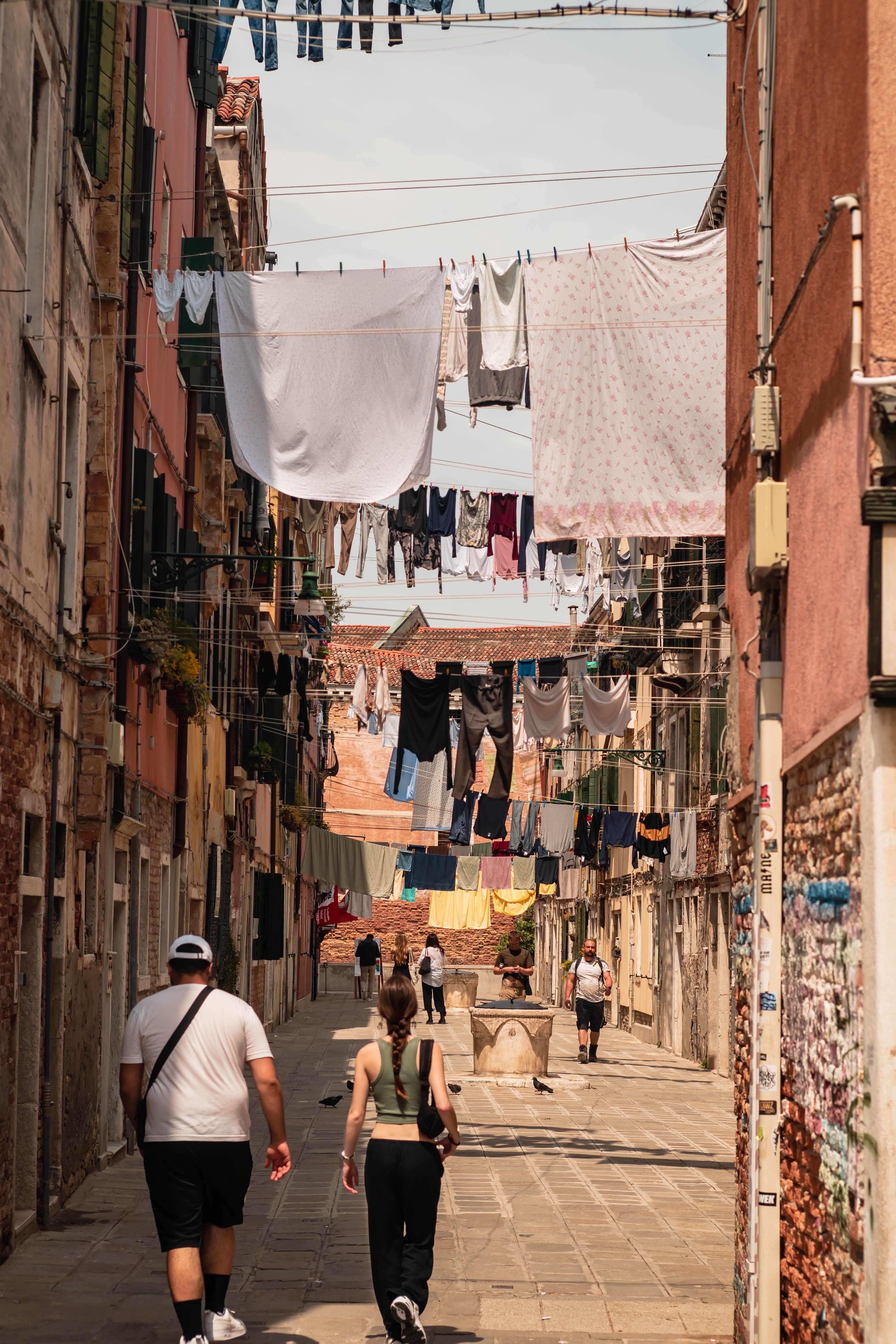 Laundry Drying over Tourists on the Walkway Between Townhouses · Free ...