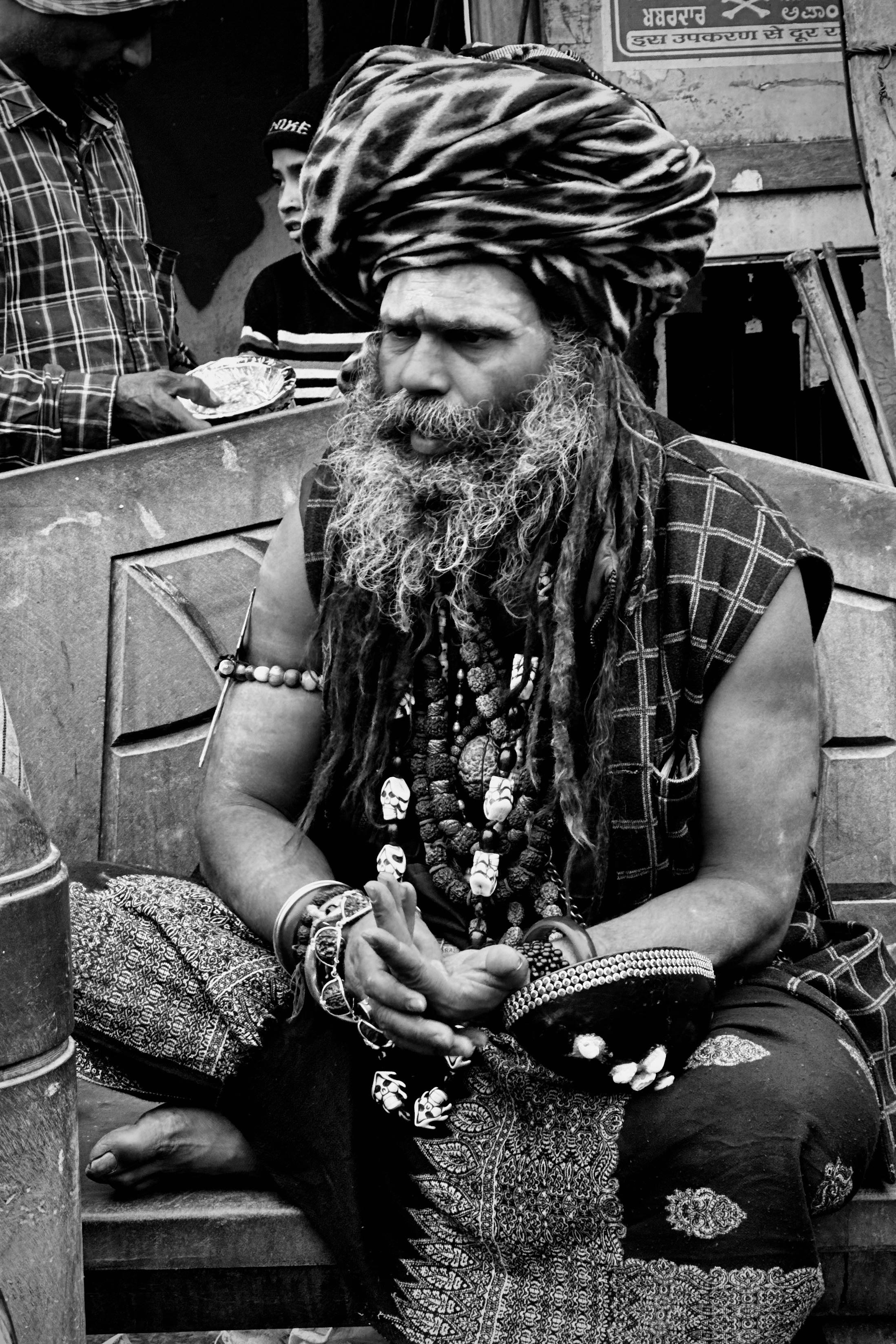 Sadhu in Turban and Necklaces Sitting Cross-legged on a Bench · Free ...