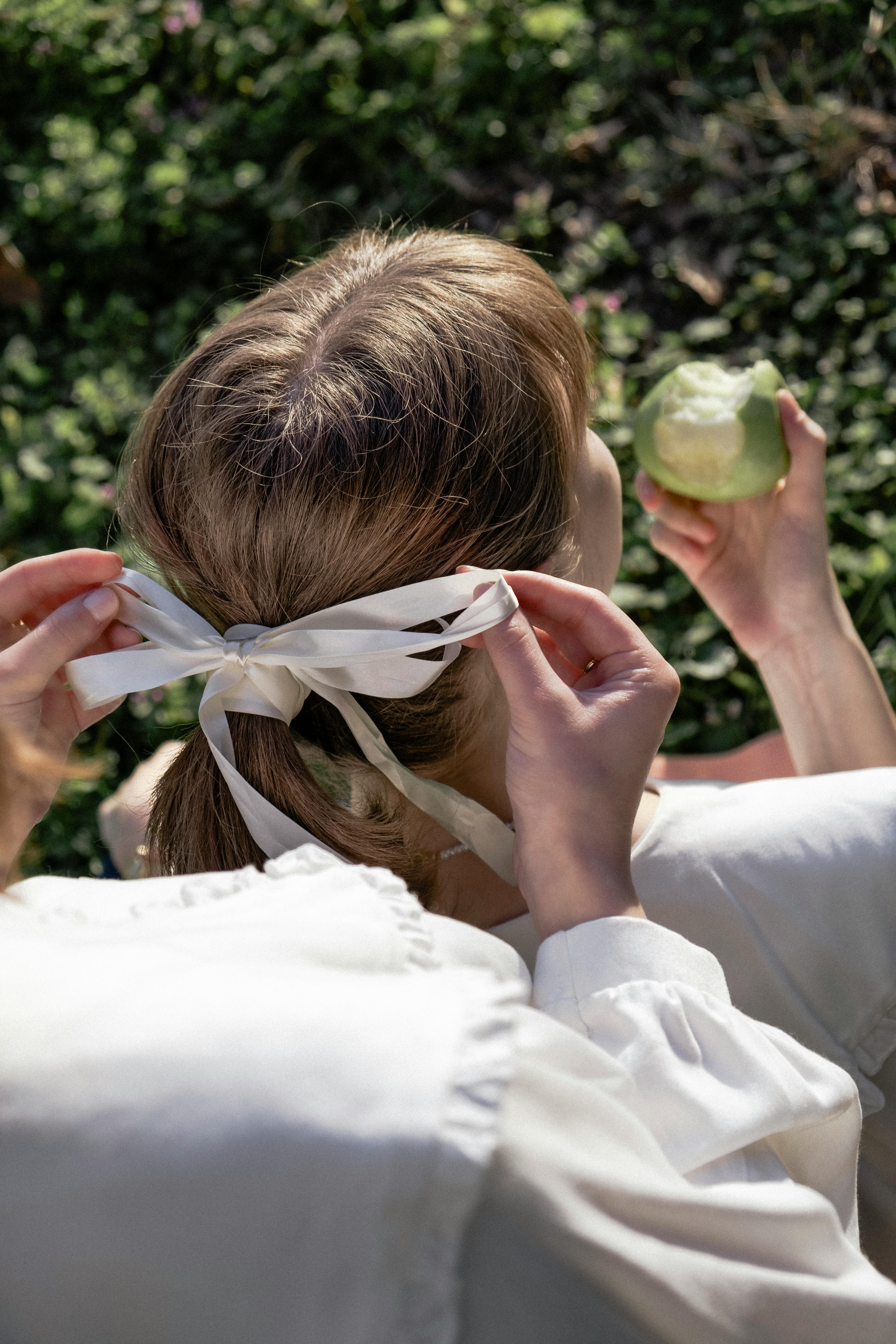 Hands Tying Ribbon in Hair of Girl · Free Stock Photo