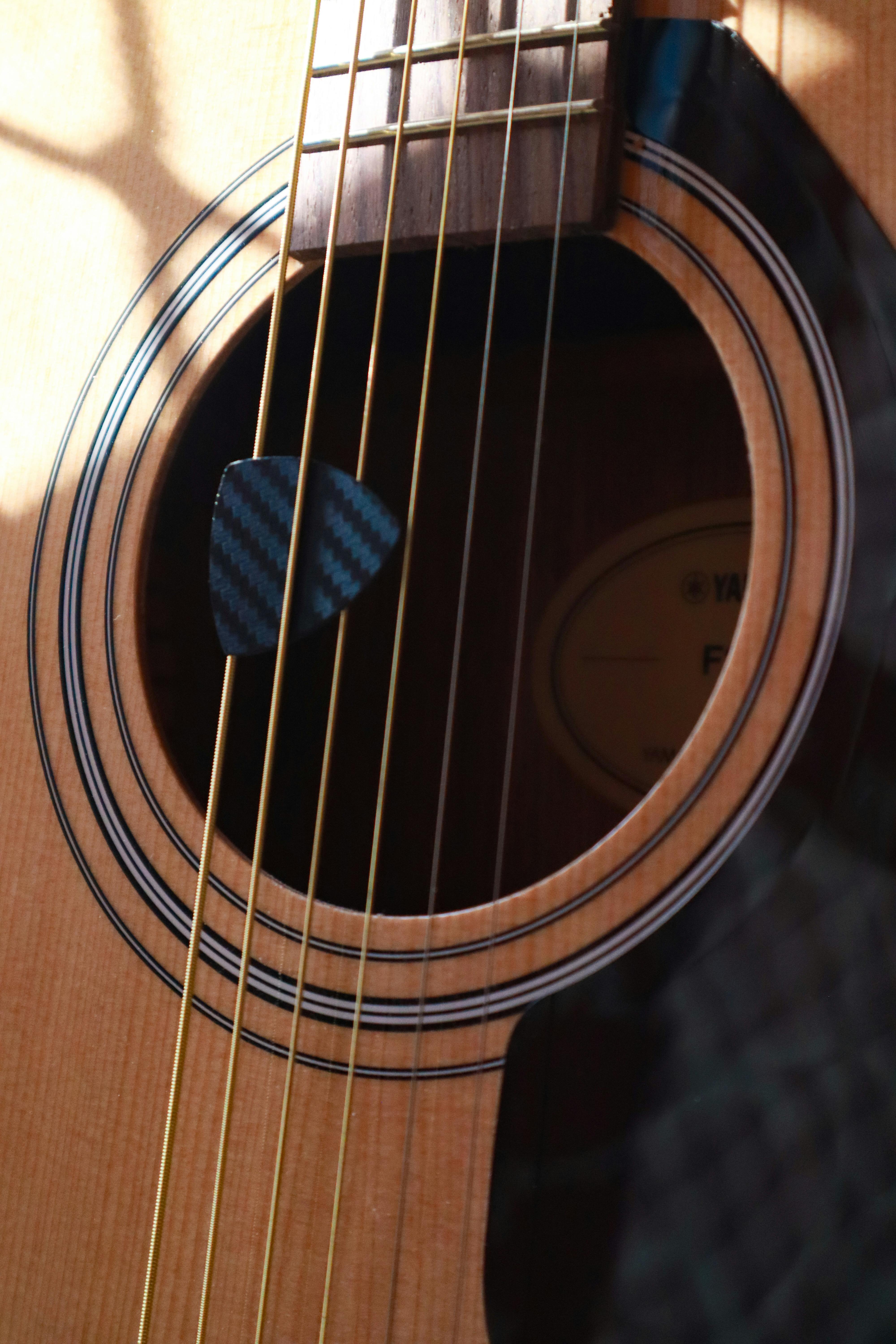Pick Between String of Acoustic Guitar · Free Stock Photo