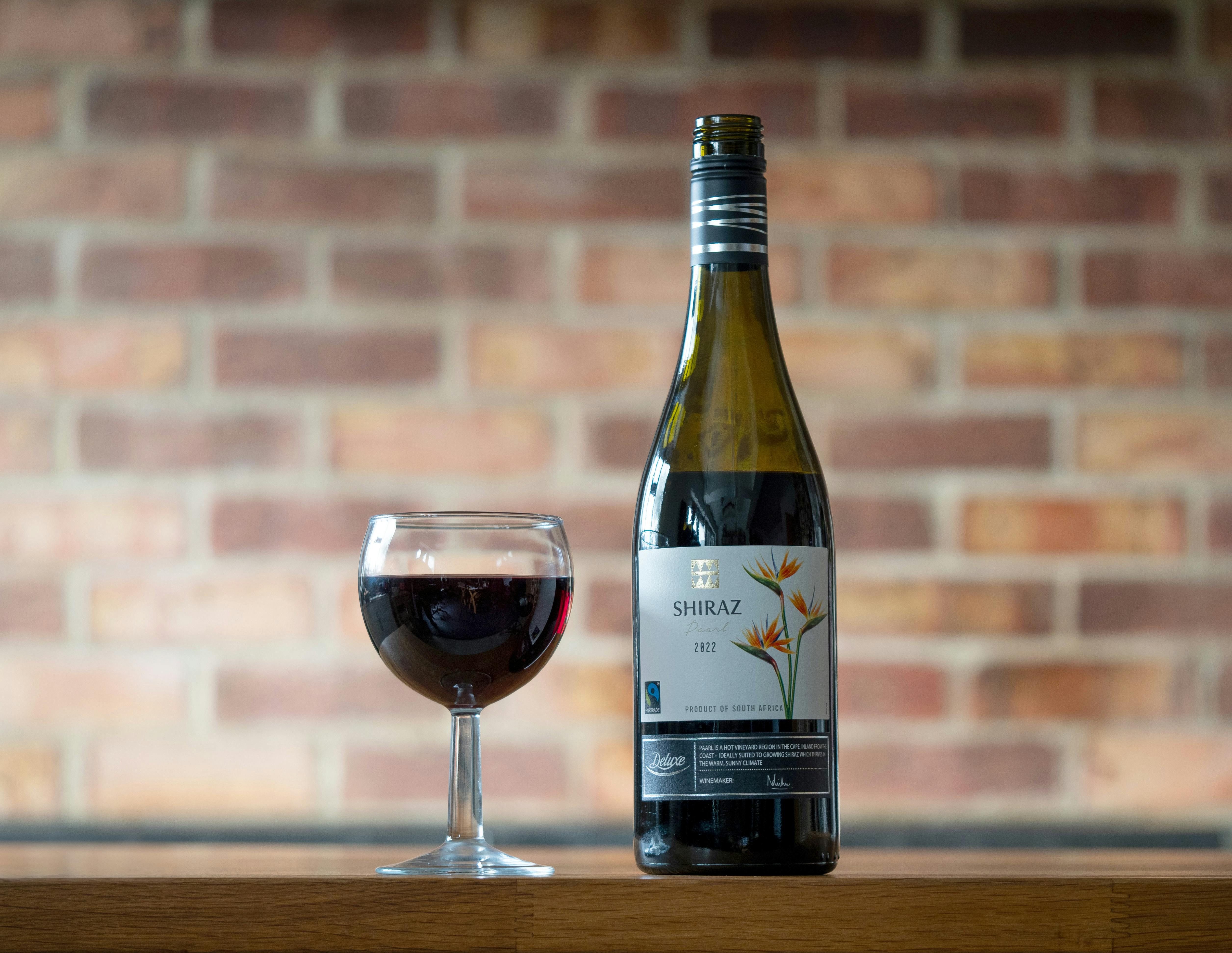 Red Wine in Glass by Bottle · Free Stock Photo