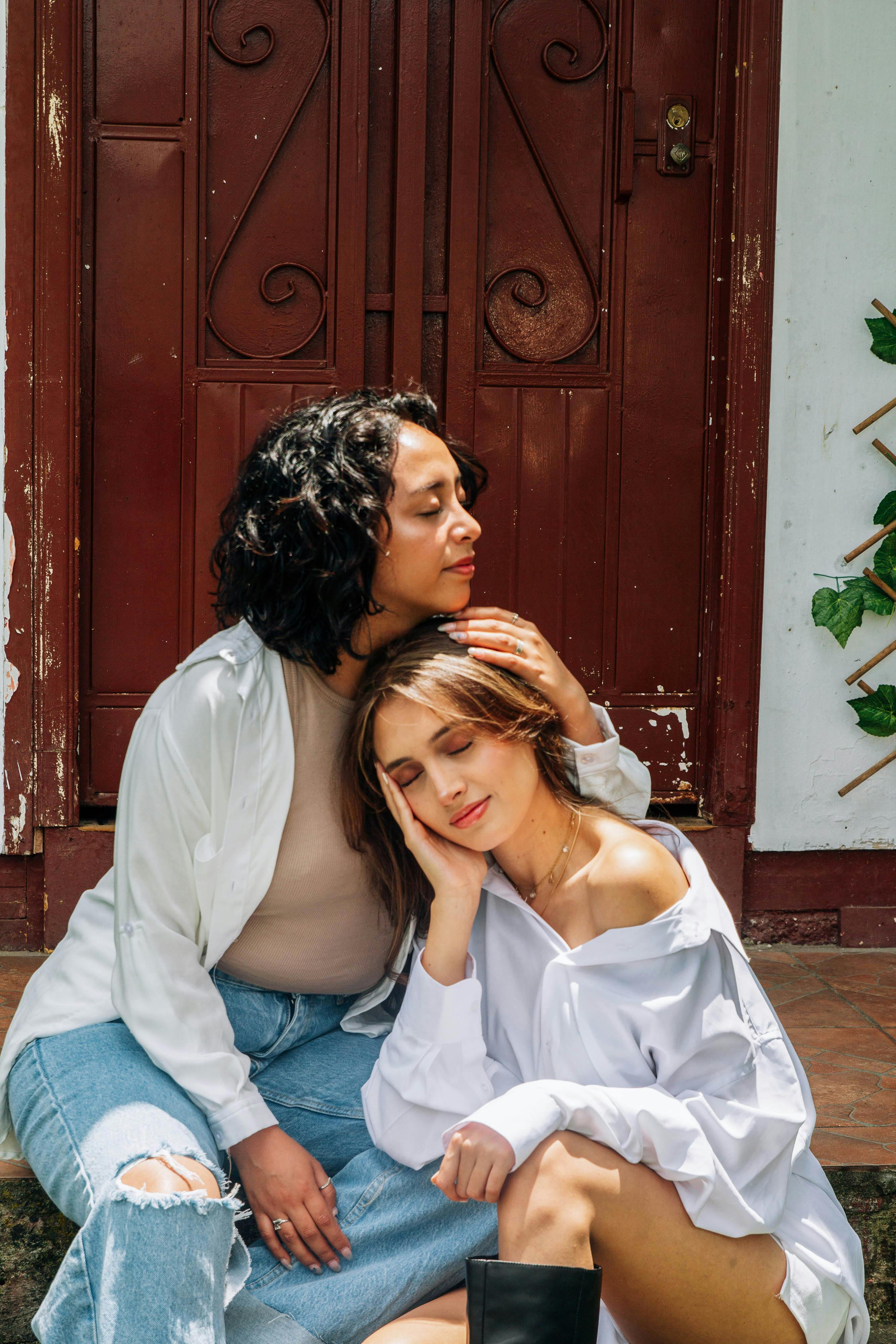 Woman Hugging a Young Woman at the Entrance of a House · Free Stock Photo
