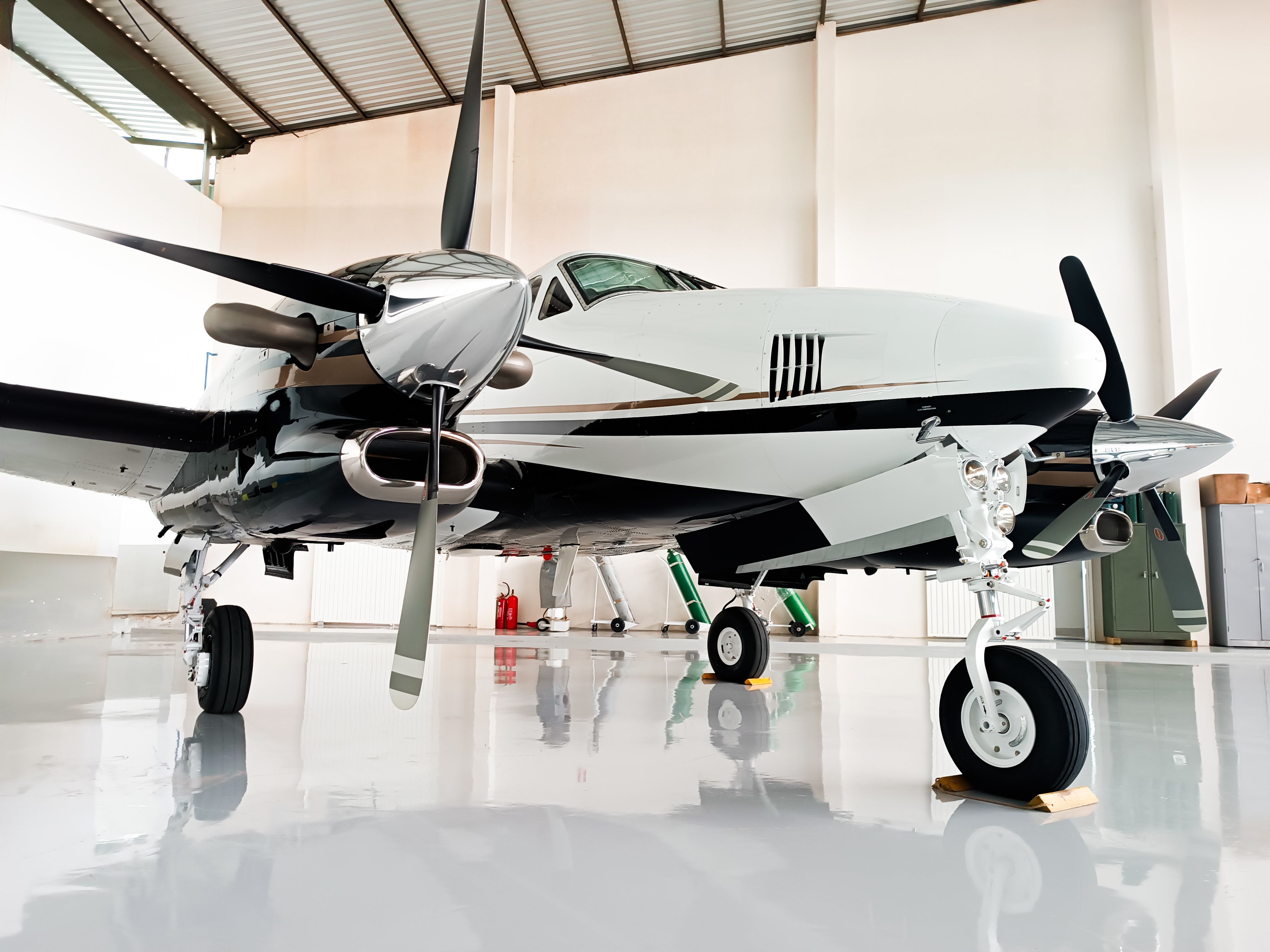 Small Aircraft Standing in a Bright Garage Hall · Free Stock Photo