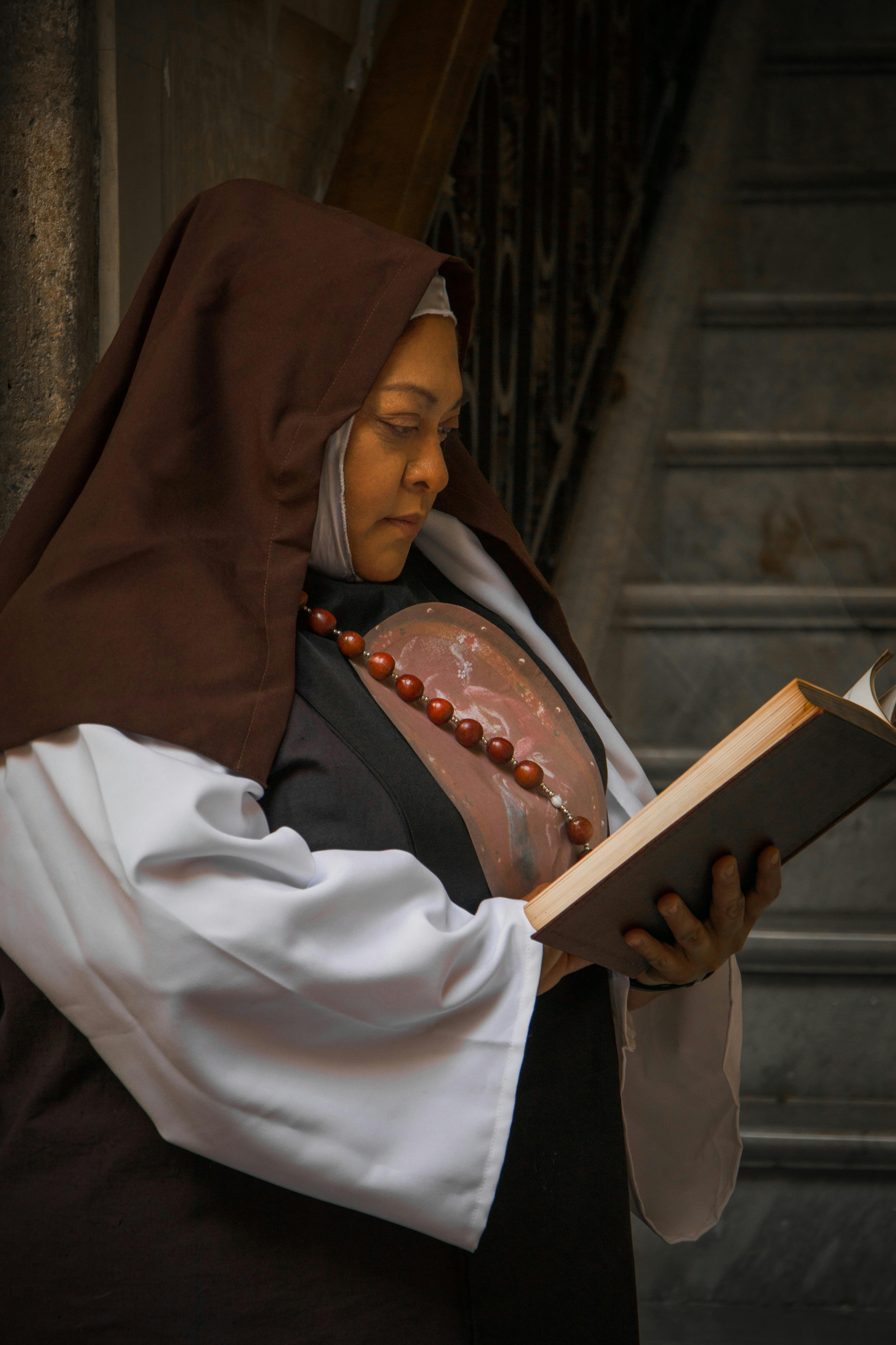 Nun Sitting with Bible · Free Stock Photo
