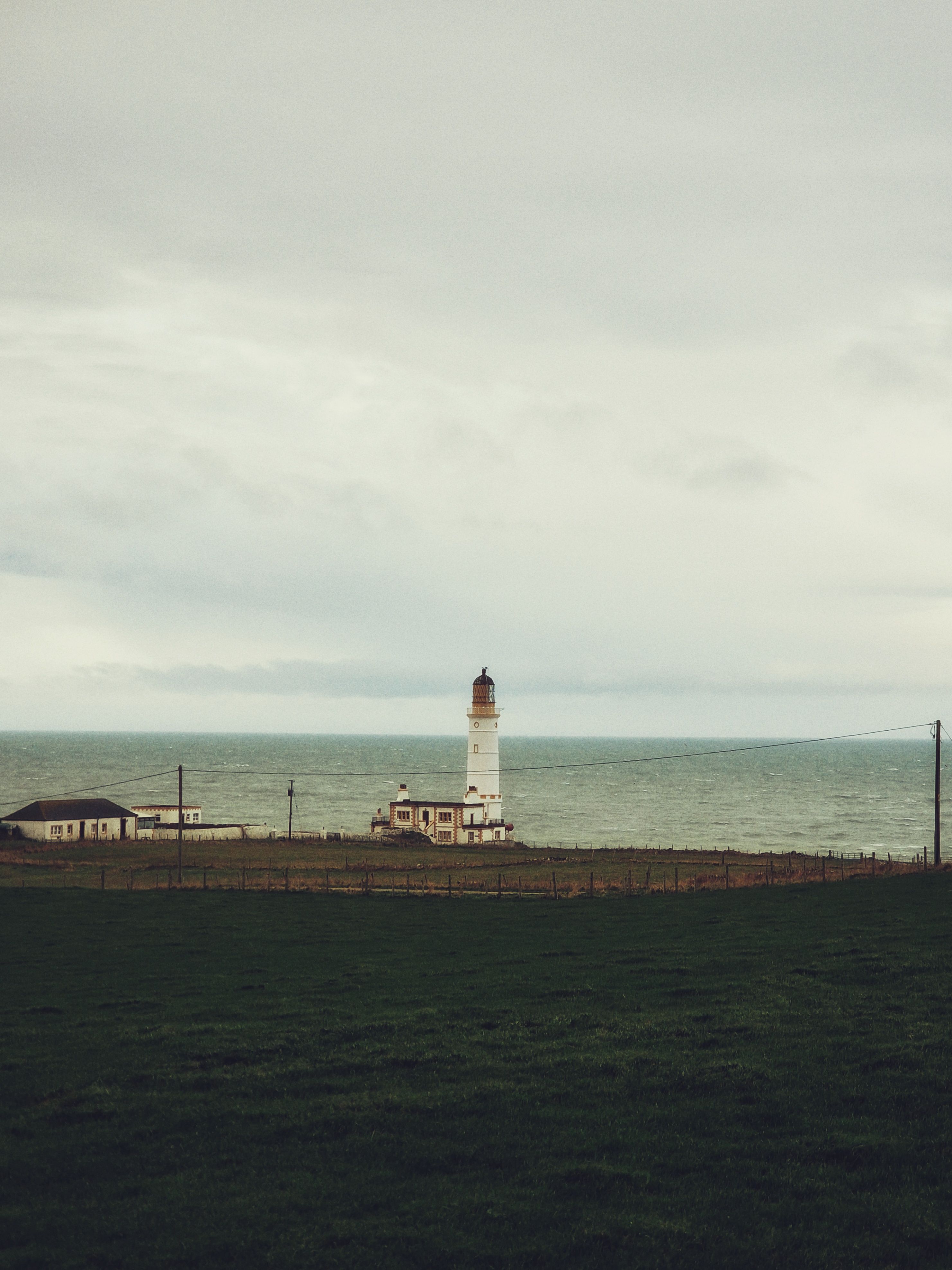 Small Lighthouse in the Distance Overlooking Sea · Free Stock Photo