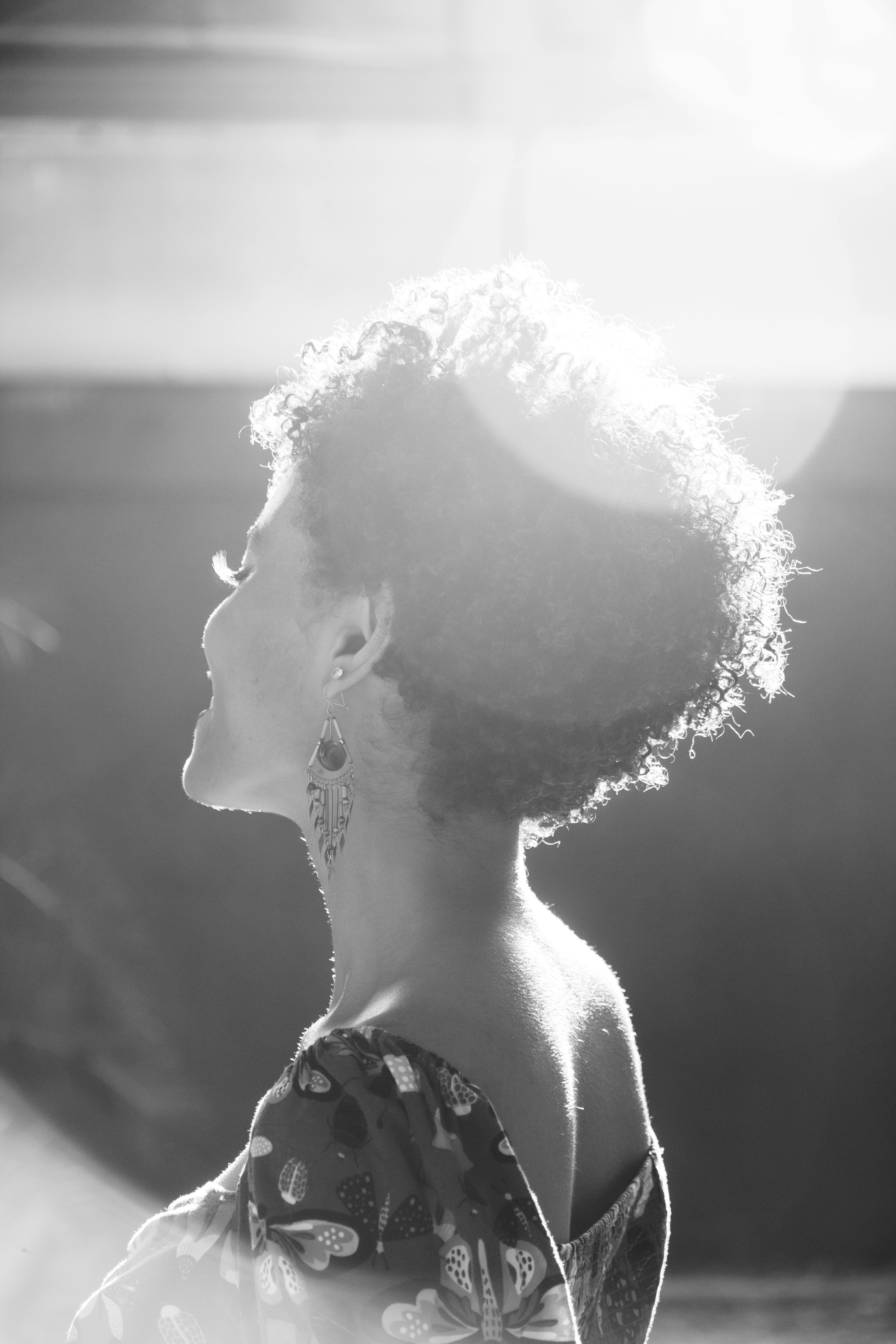 Black and White Side View of a Woman in a Blouse with a Floral Pattern ...