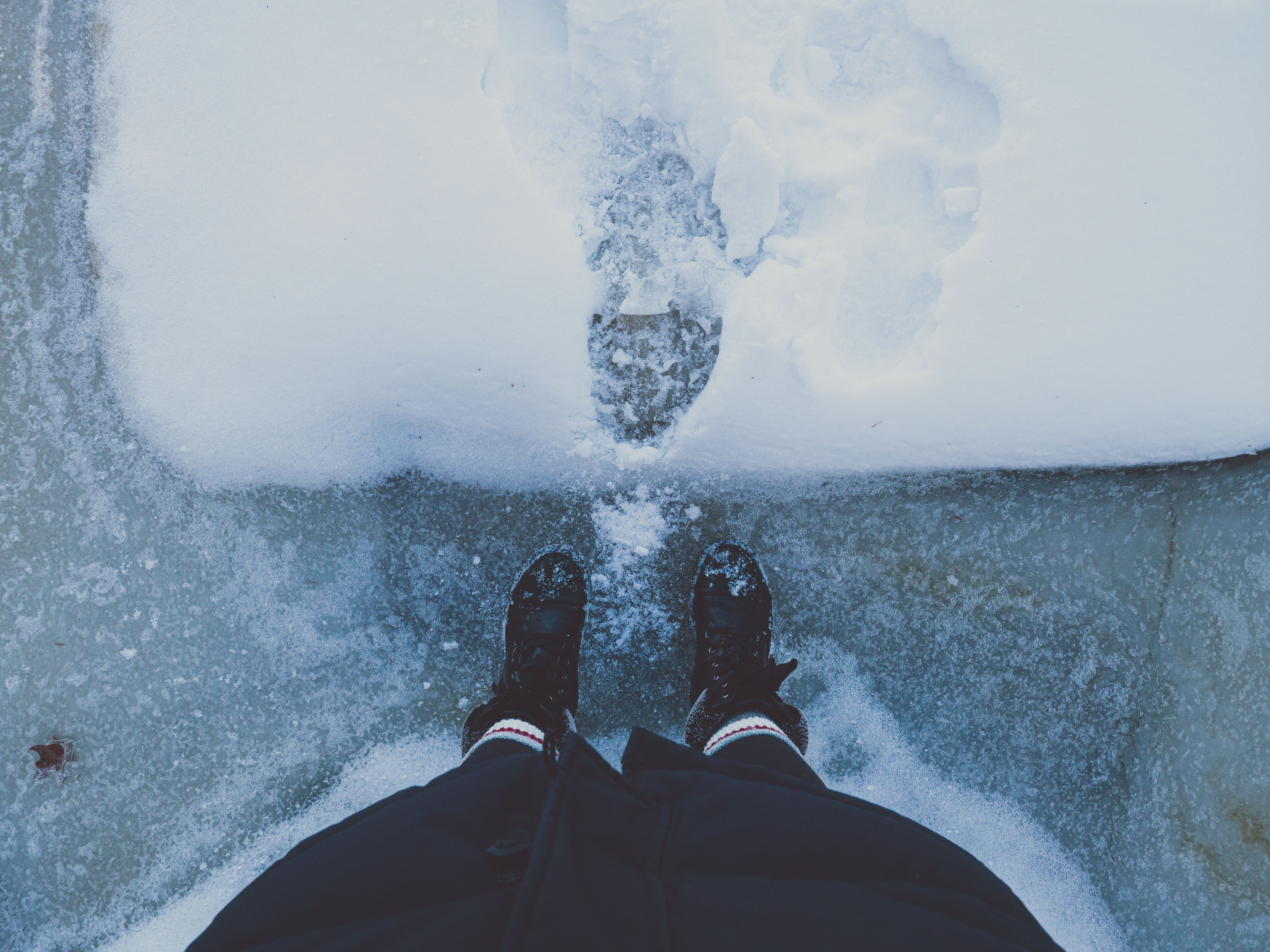 Standing on the Ice in Front of a Large Footprint in the Snow on the ...