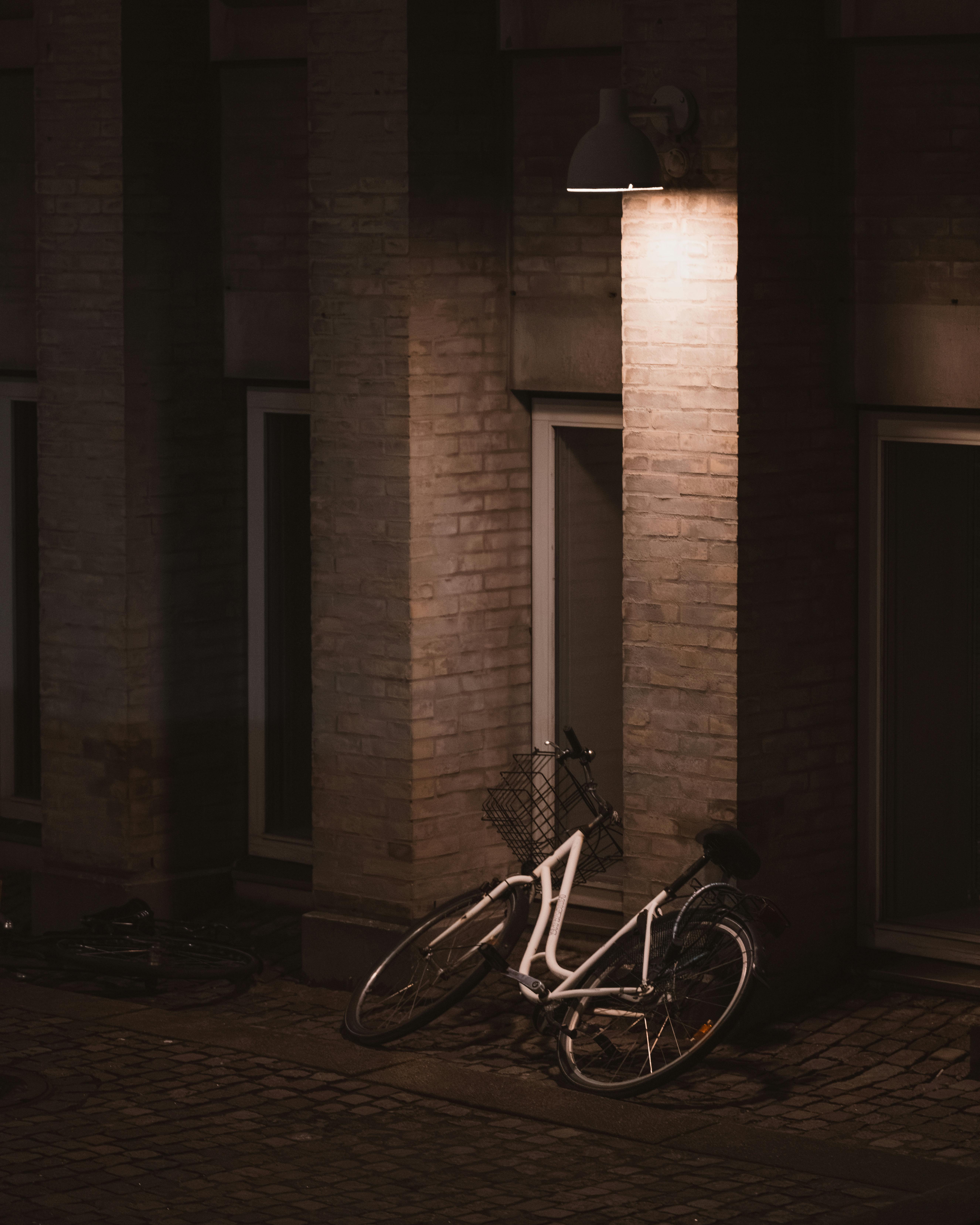 Bike with Basket Lying Down on Sidewalk · Free Stock Photo