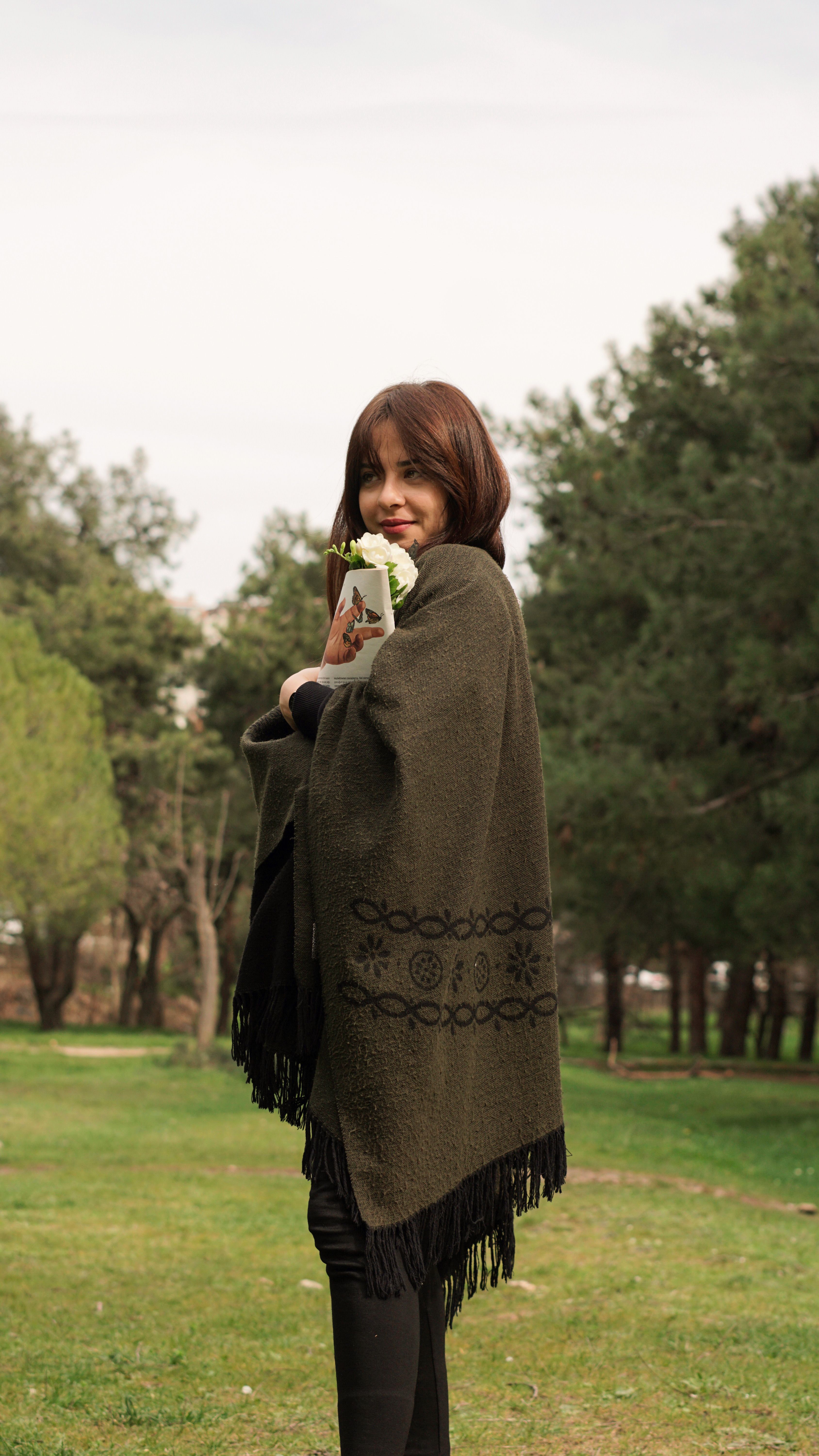 Woman in Poncho Standing at Park · Free Stock Photo