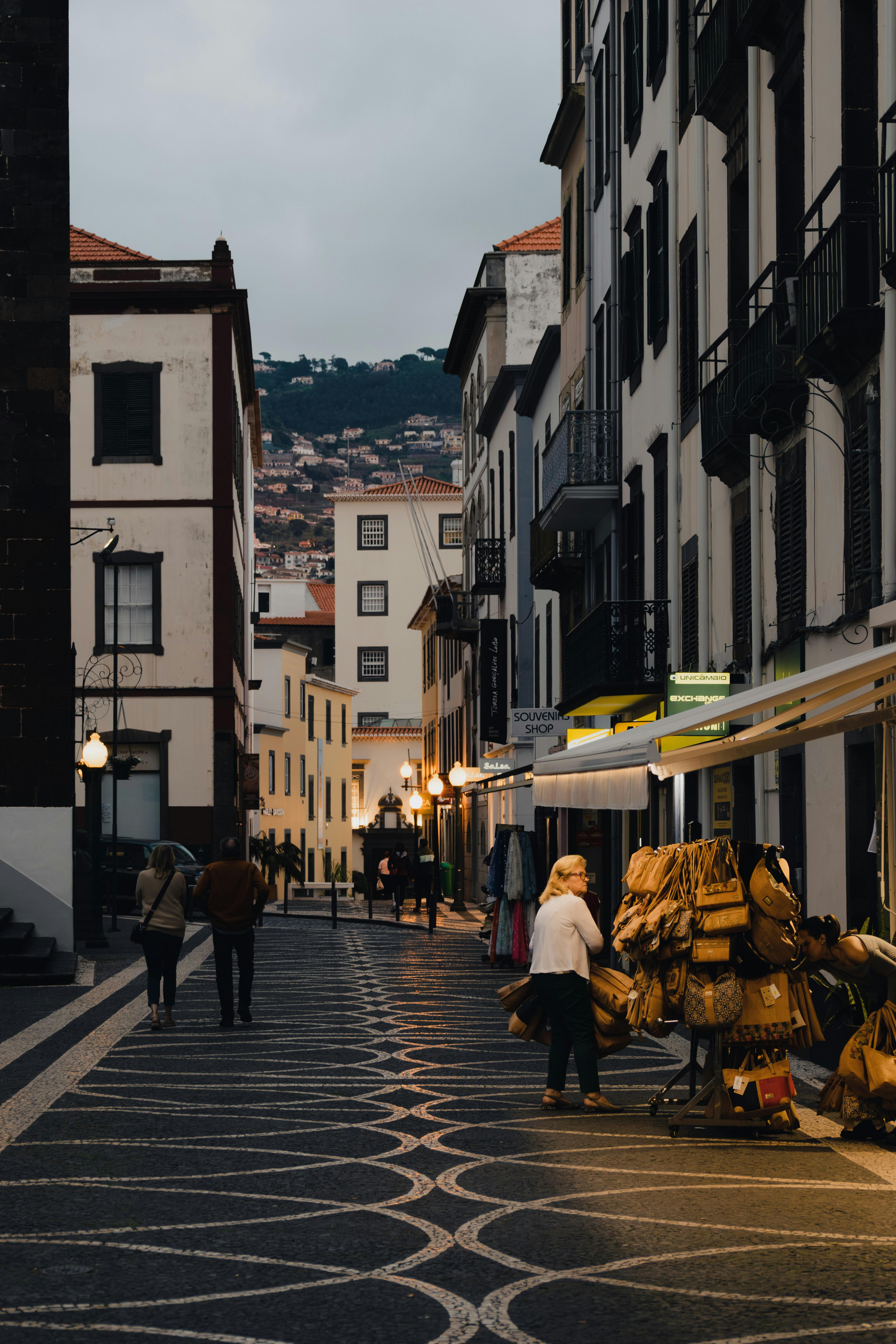 PeOple Walking Between Buildings · Free Stock Photo