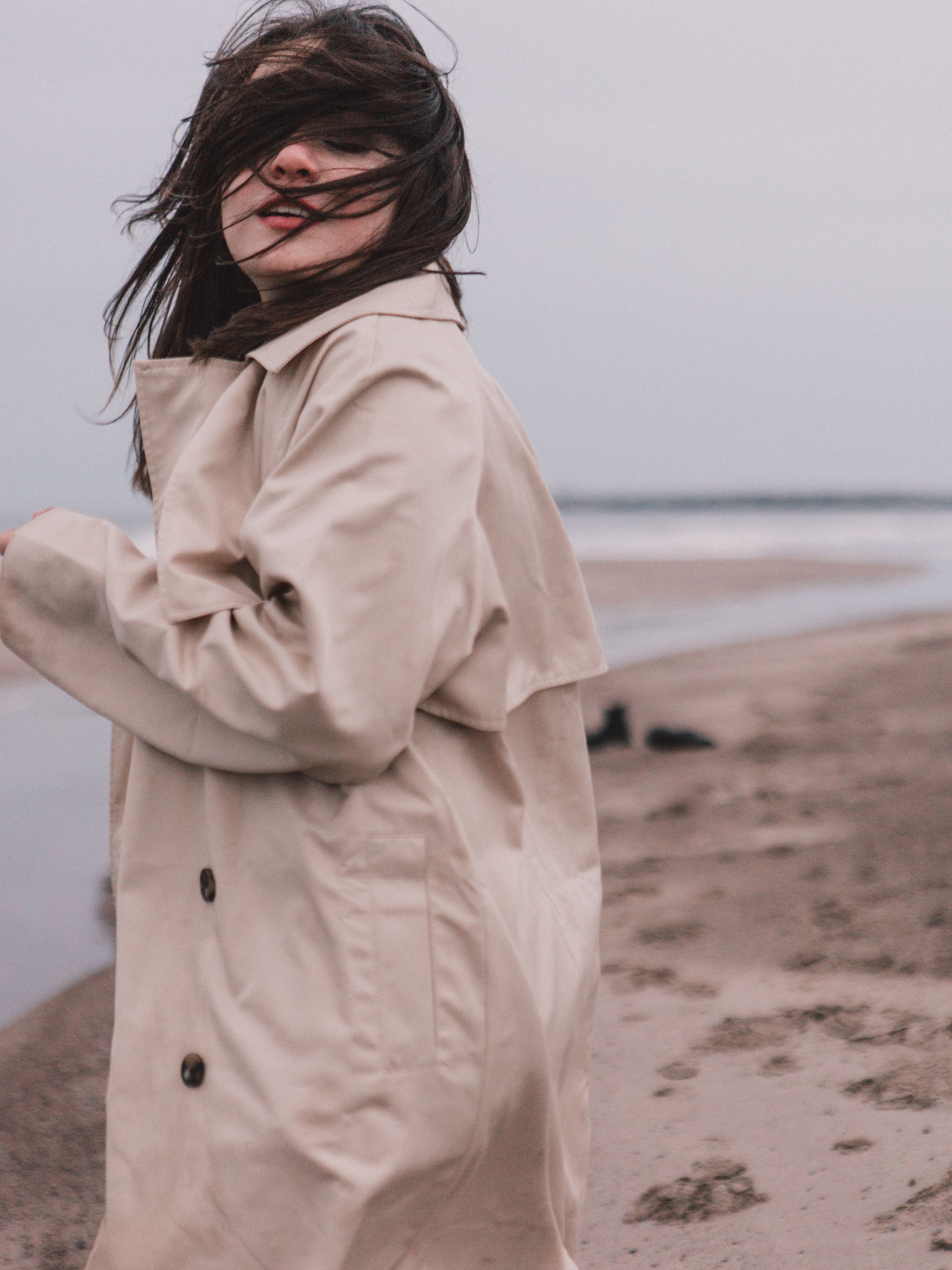 Portrait of Woman in Trench on Beach · Free Stock Photo