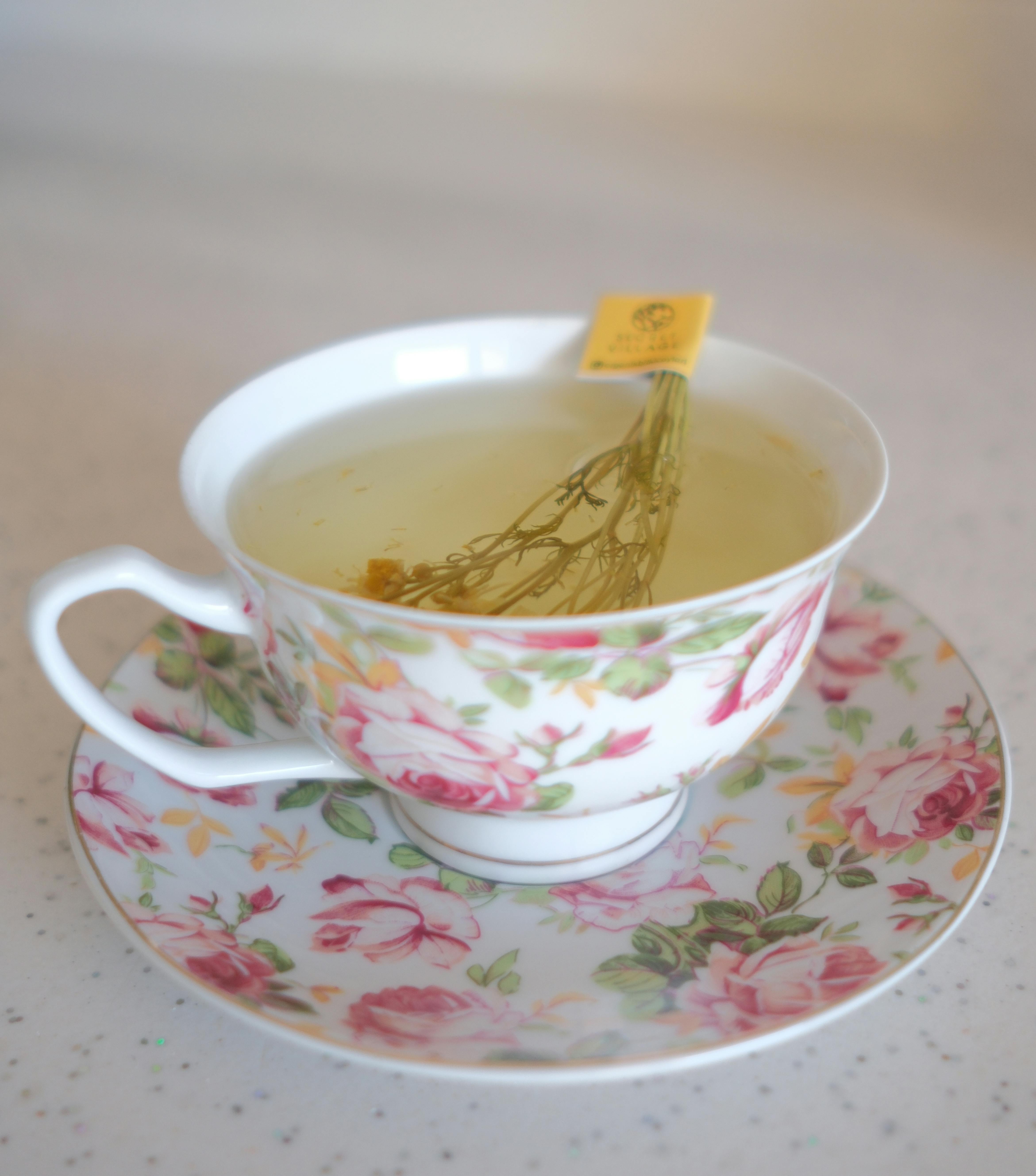 Silver-colored Teacup With Stirrer on Brown Wooden Table · Free Stock Photo