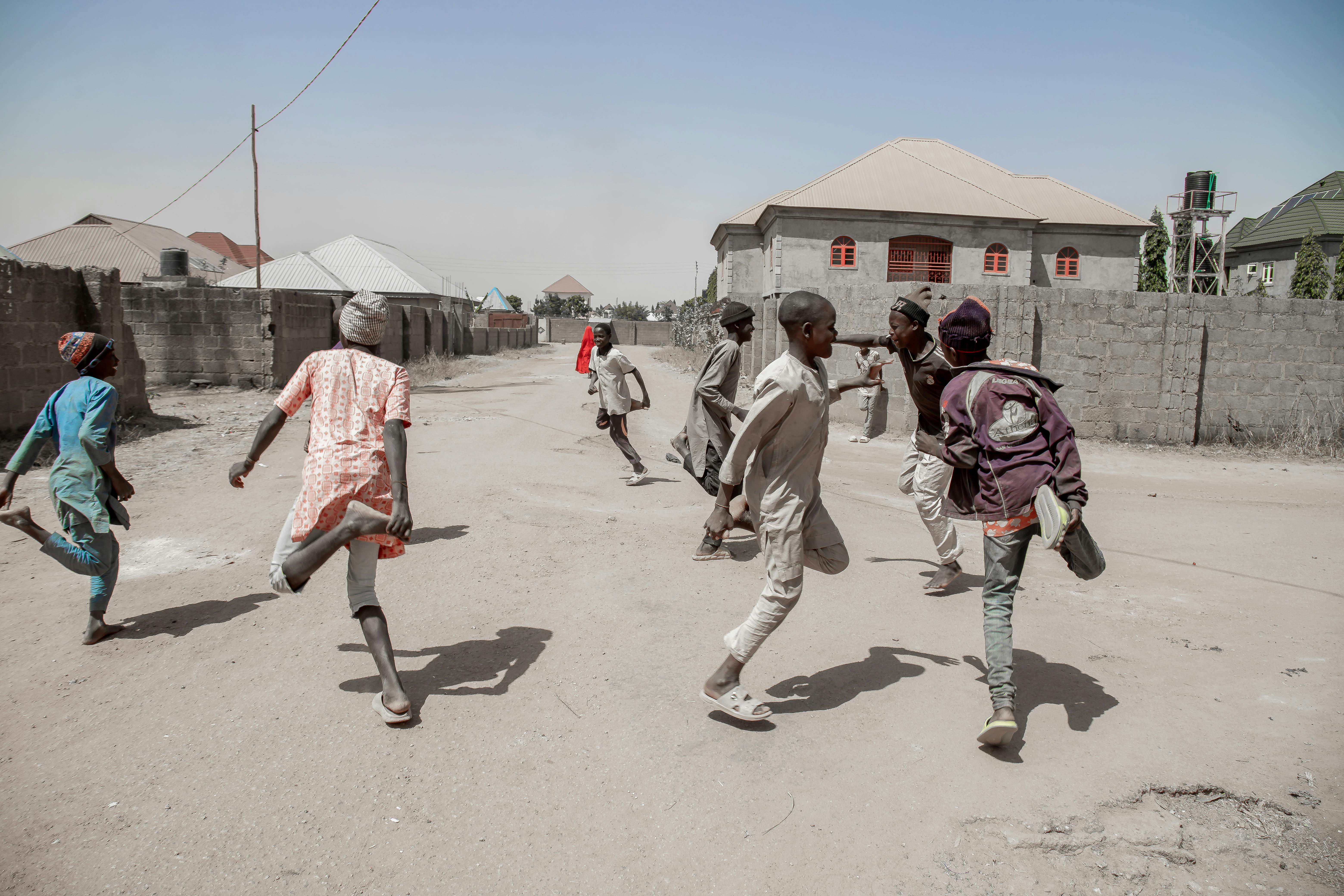 Boys Running on a Street in a Village · Free Stock Photo