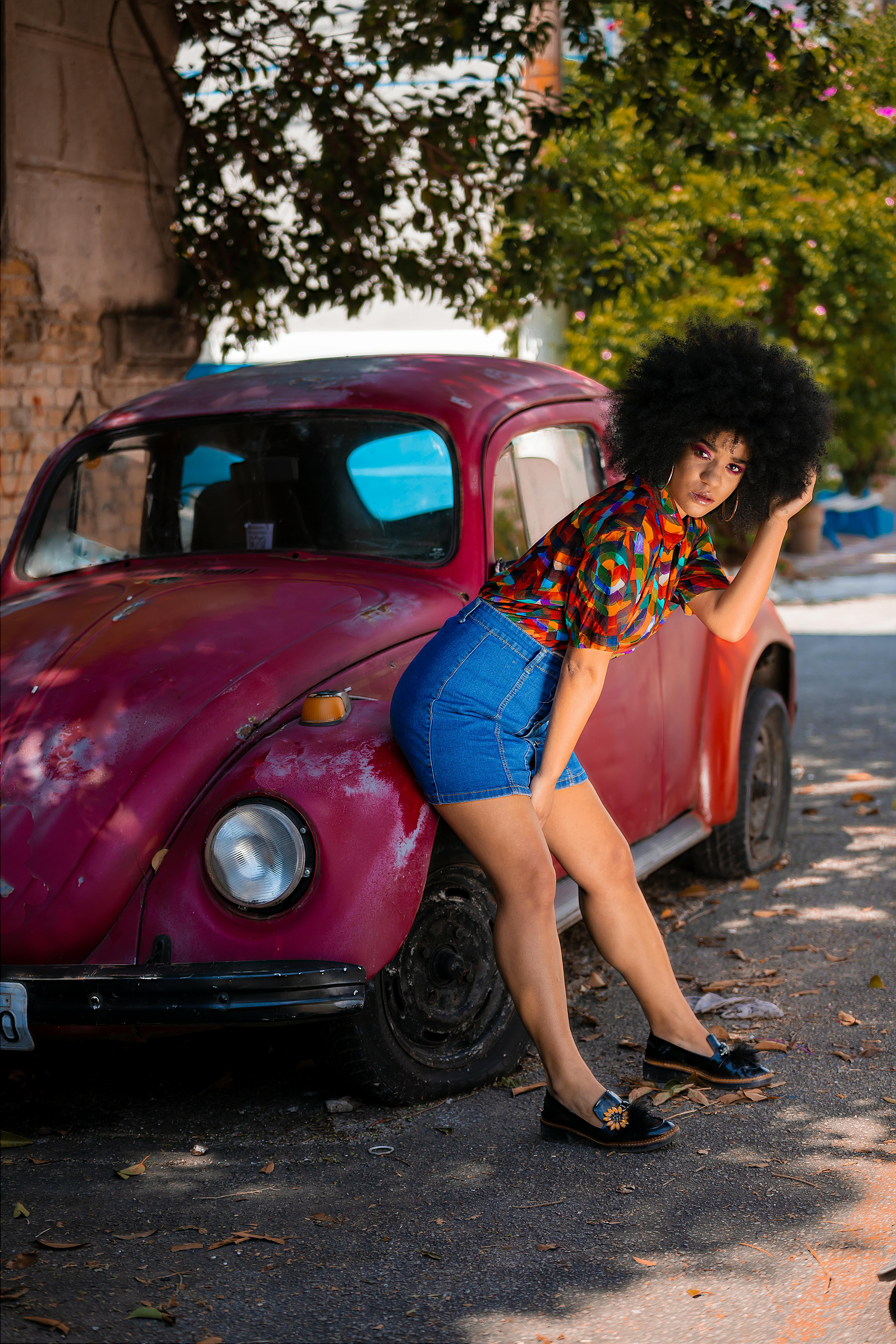 A Beautiful Woman Projecting on the Camera while Leaning on a Minivan ...