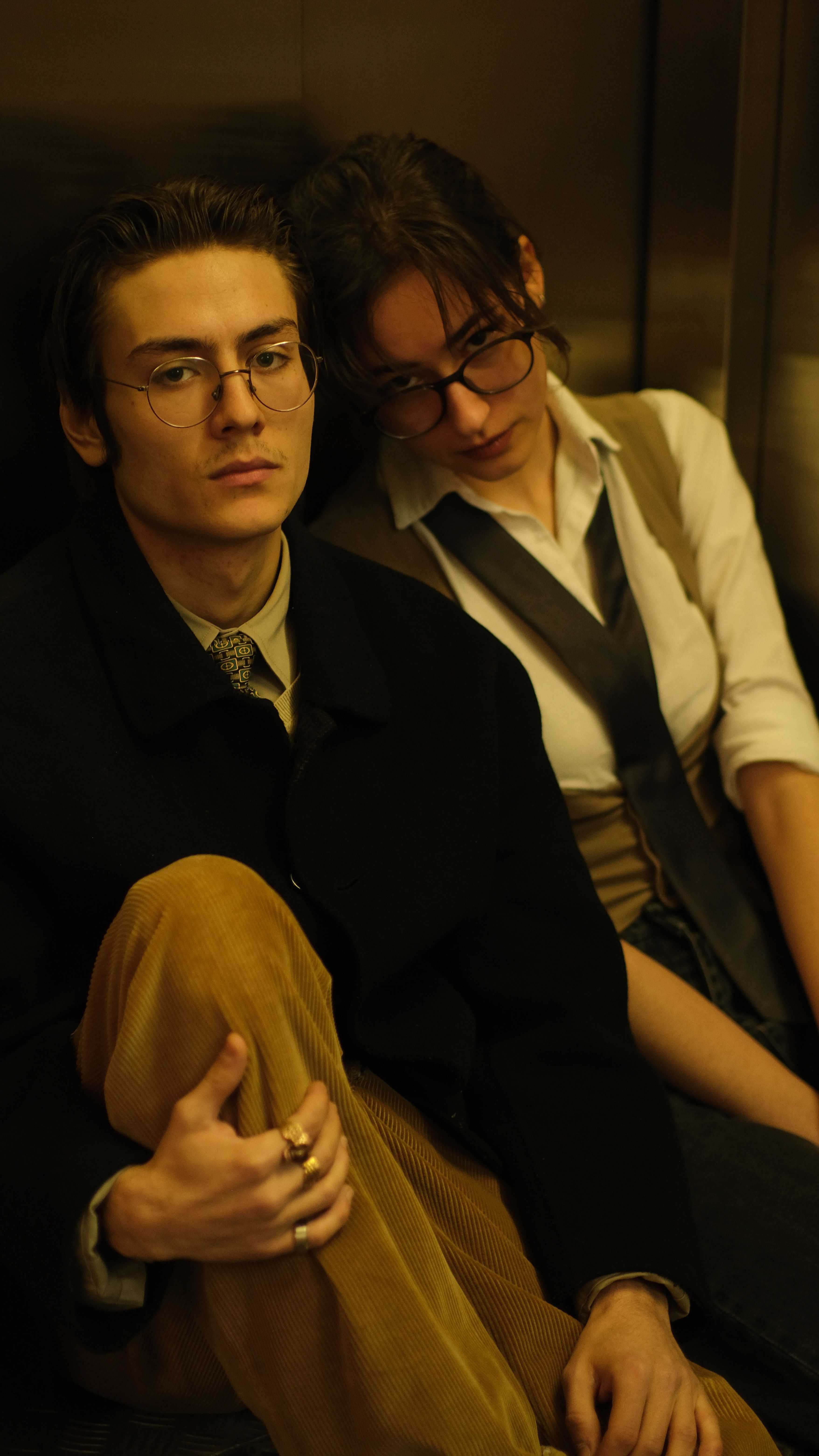 A man and woman sitting on an elevator · Free Stock Photo