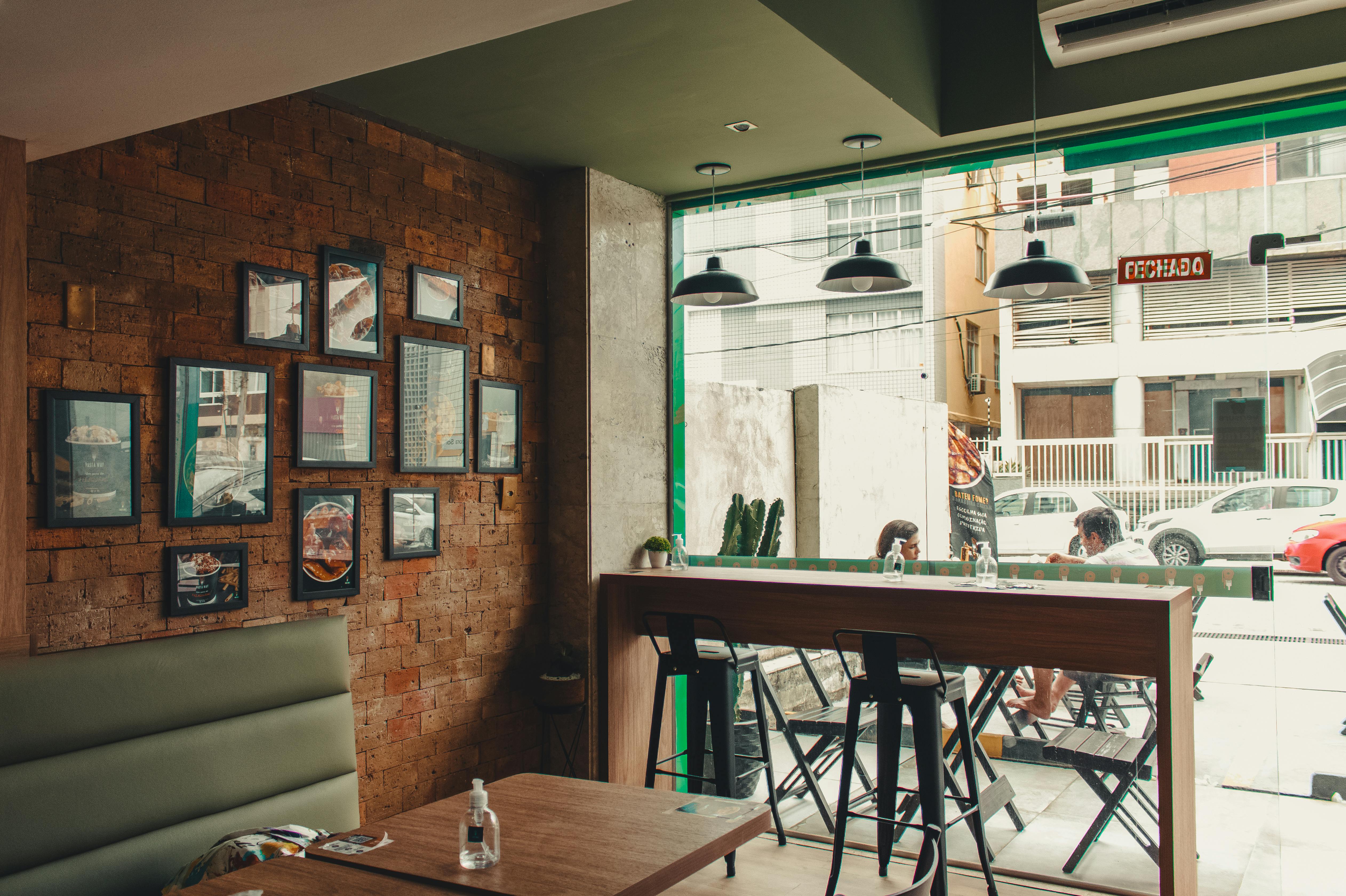 Table near Wall with Pictures in Cafe · Free Stock Photo