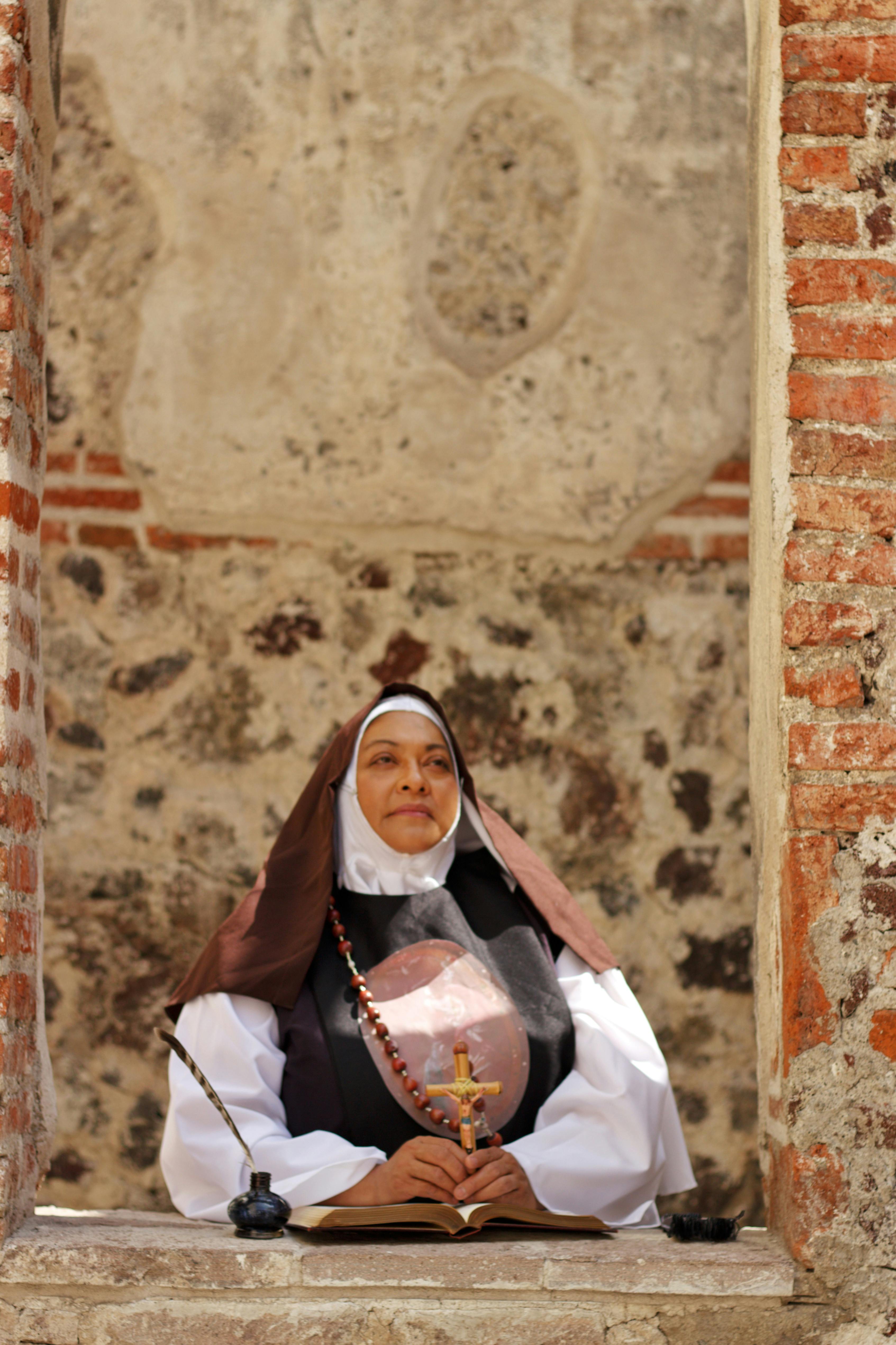 Nun Sitting with Bible · Free Stock Photo