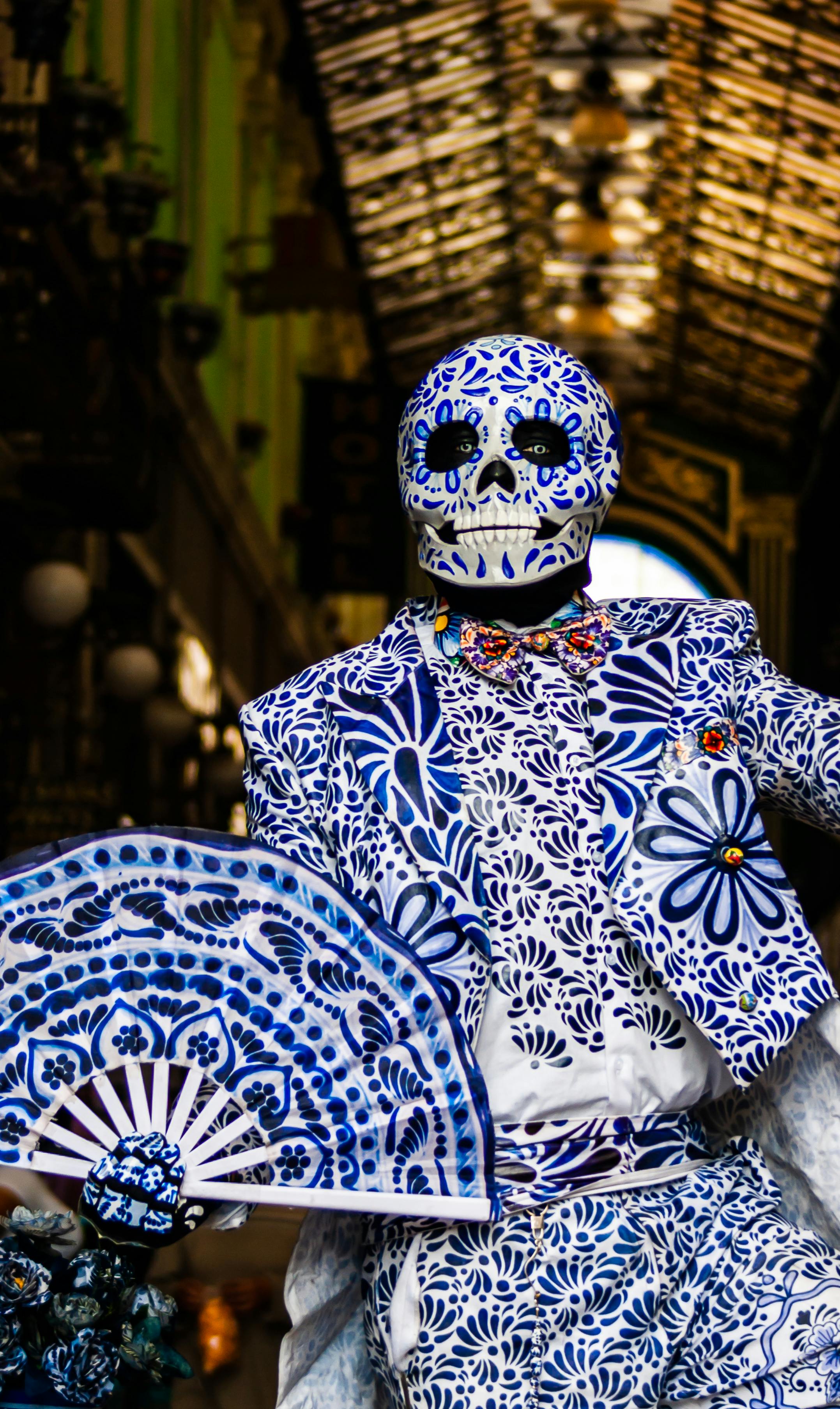 A Man in a Costume and Skull Mask with a Blue Flower Pattern · Free ...