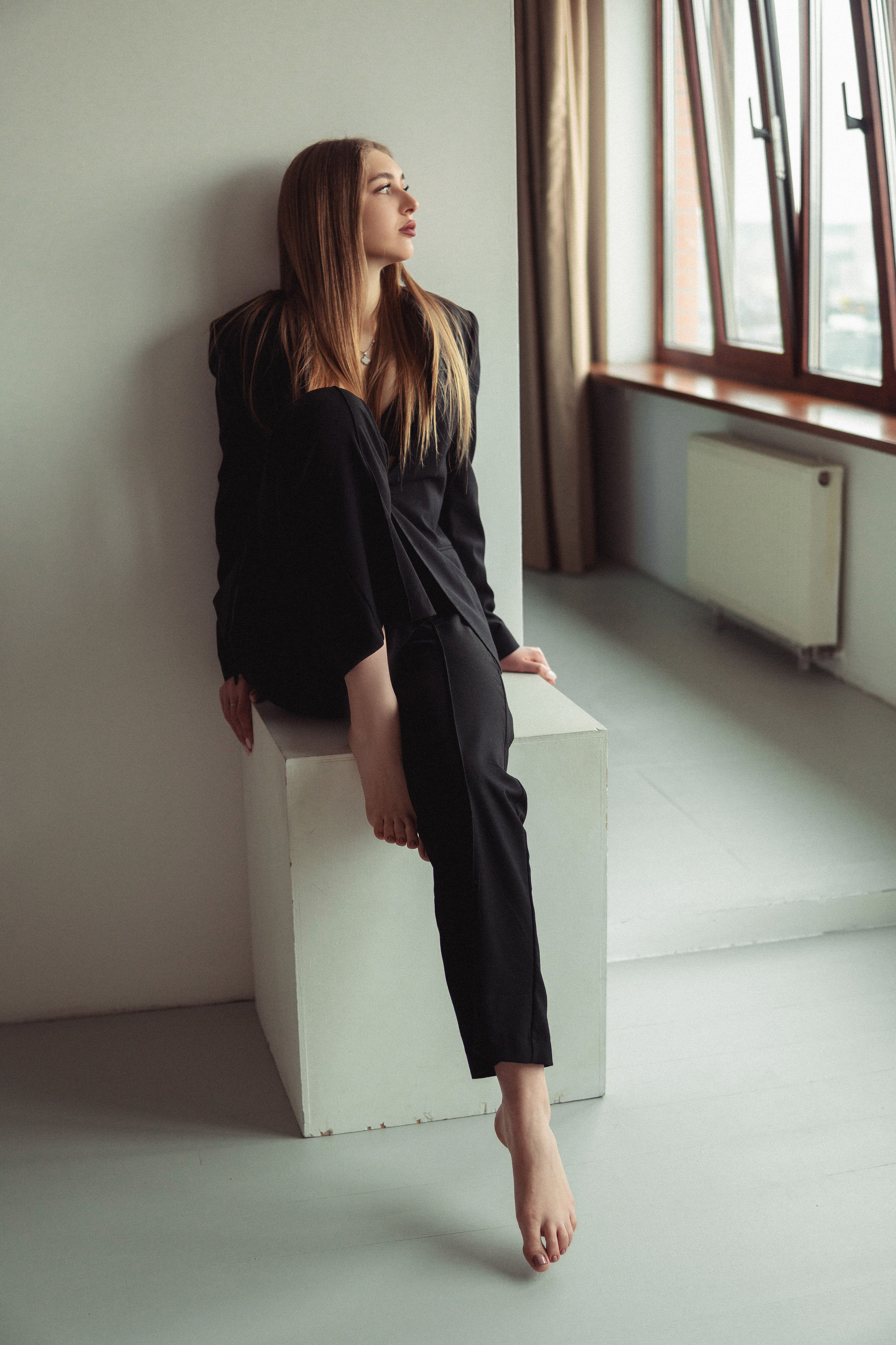 Elegant Woman Sitting on Shelf · Free Stock Photo