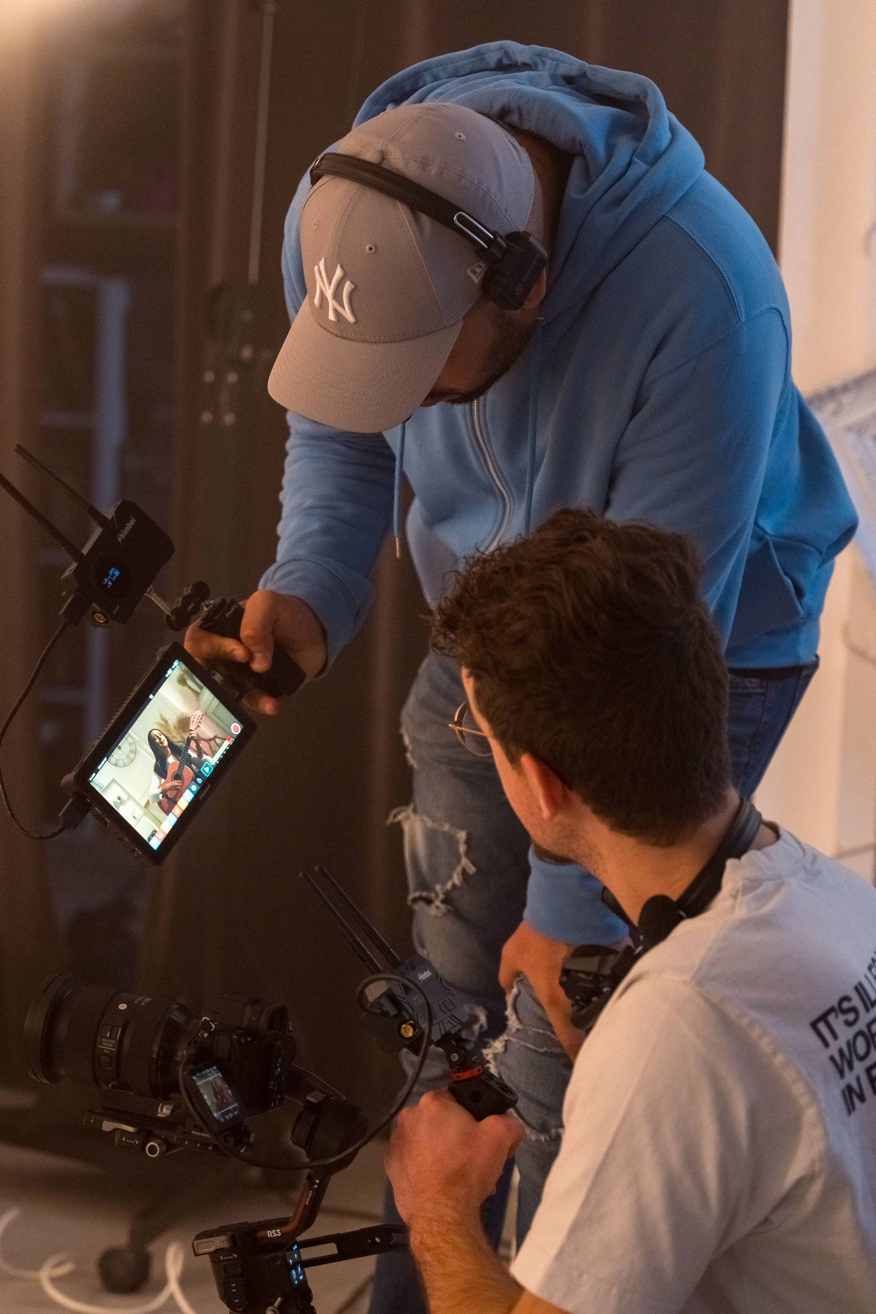 Two men are working on a video camera · Free Stock Photo