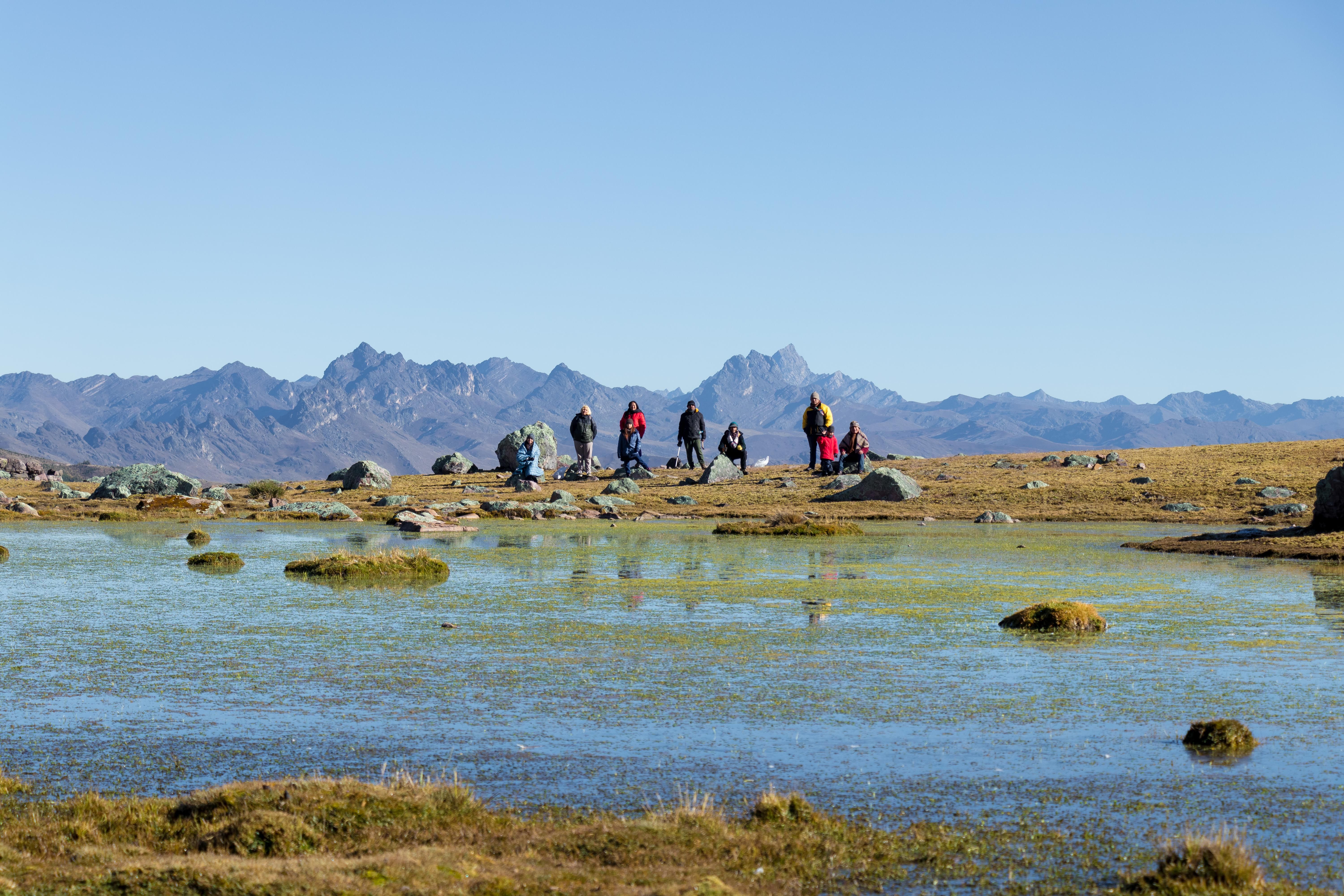 People Hiking by Lake in Countryside · Free Stock Photo
