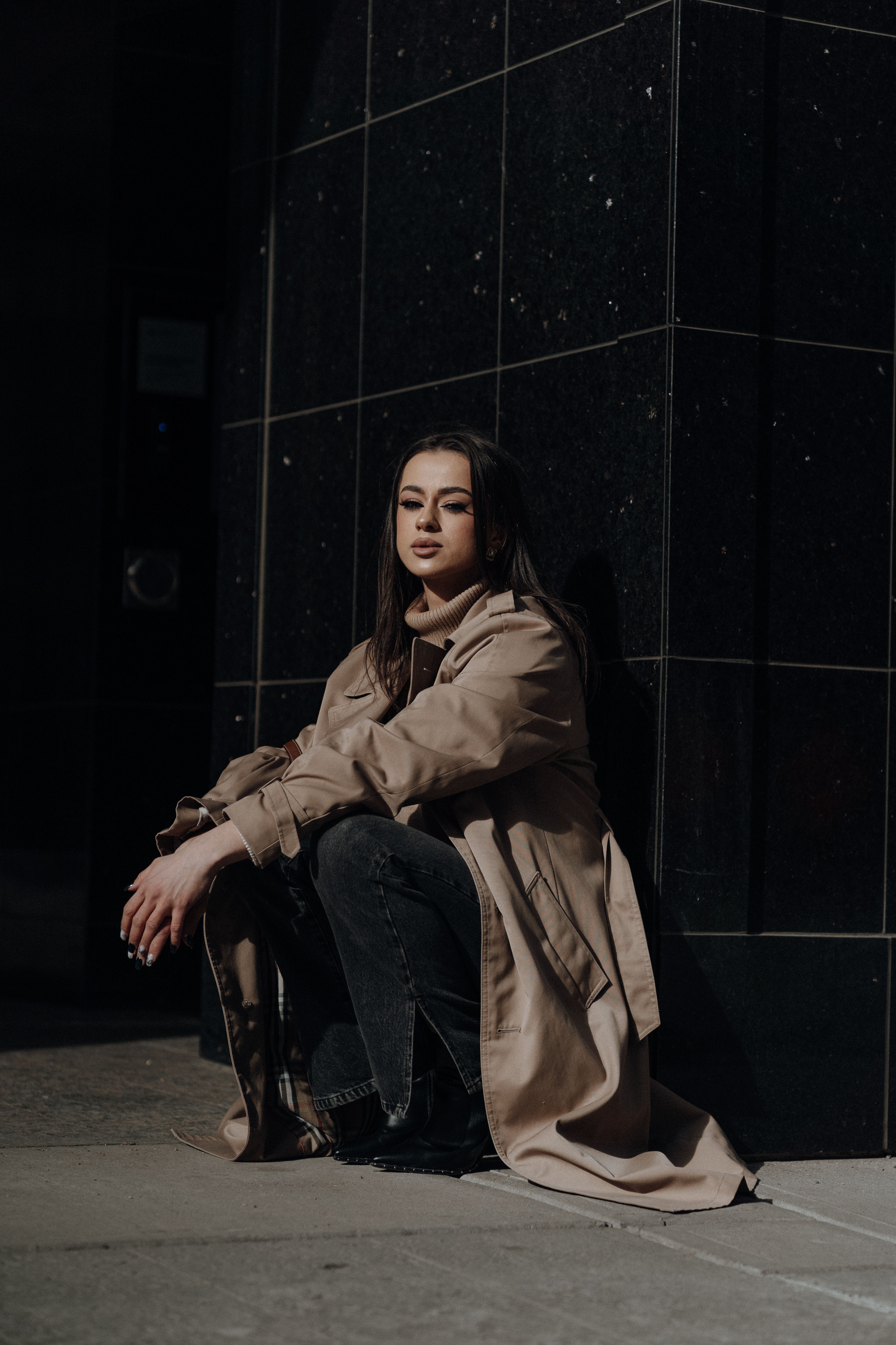 Crouching on Pavement Woman in Trench Coat and Turtleneck Sweater ...