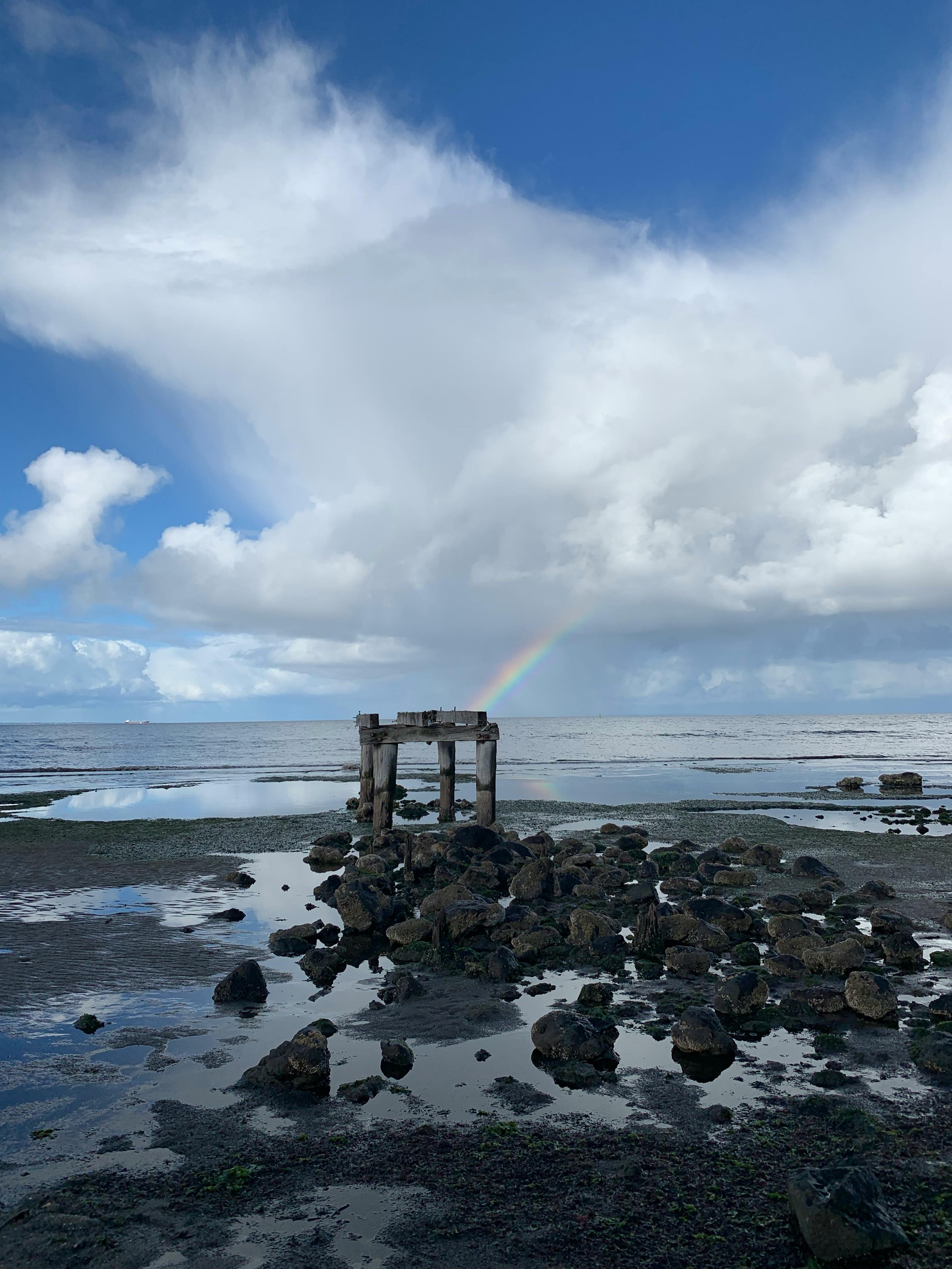 Rainbow above Stone Ruins on Sea Shore · Free Stock Photo