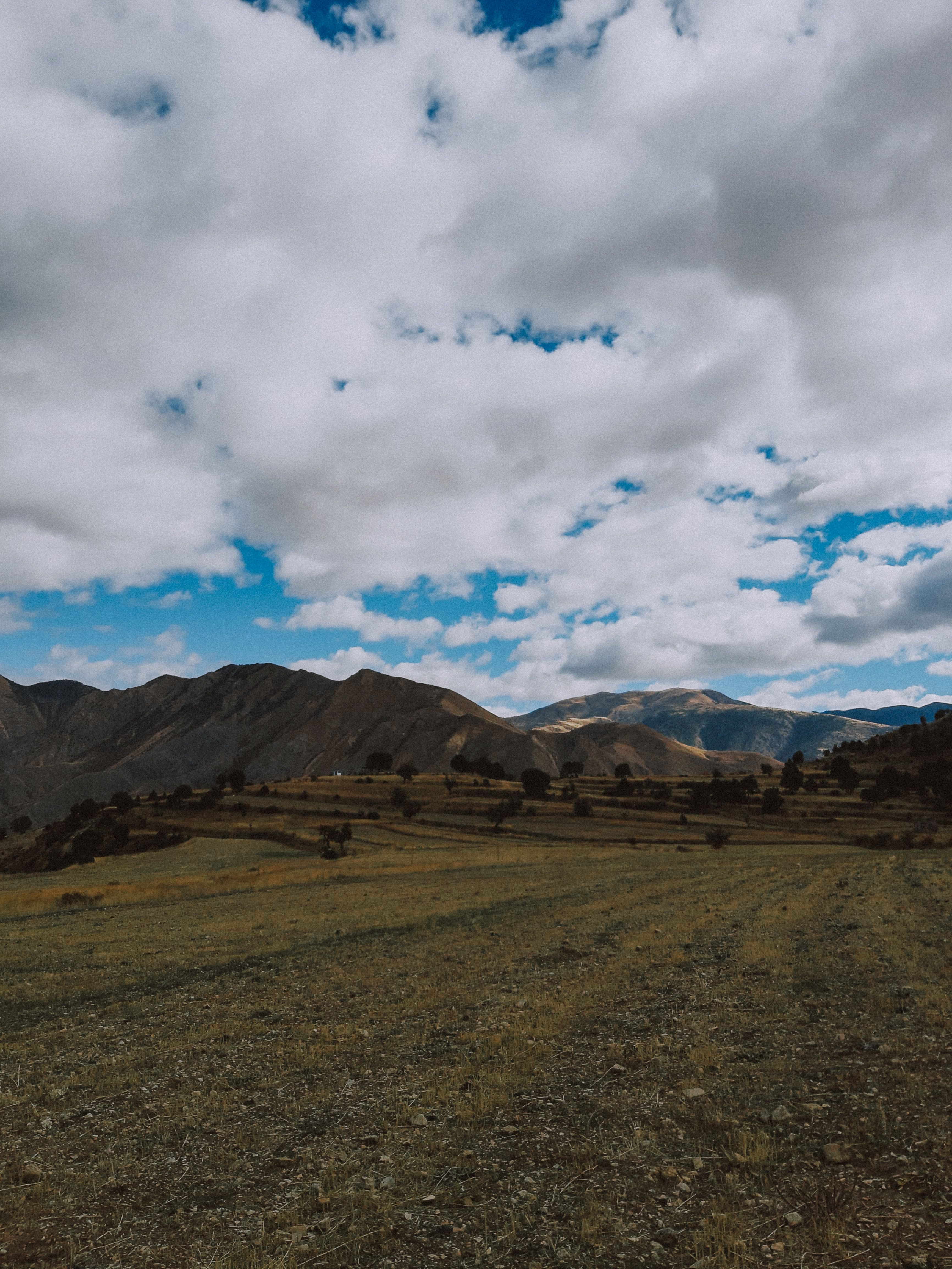 Plains under Cloudy Sky with View of Mountains · Free Stock Photo