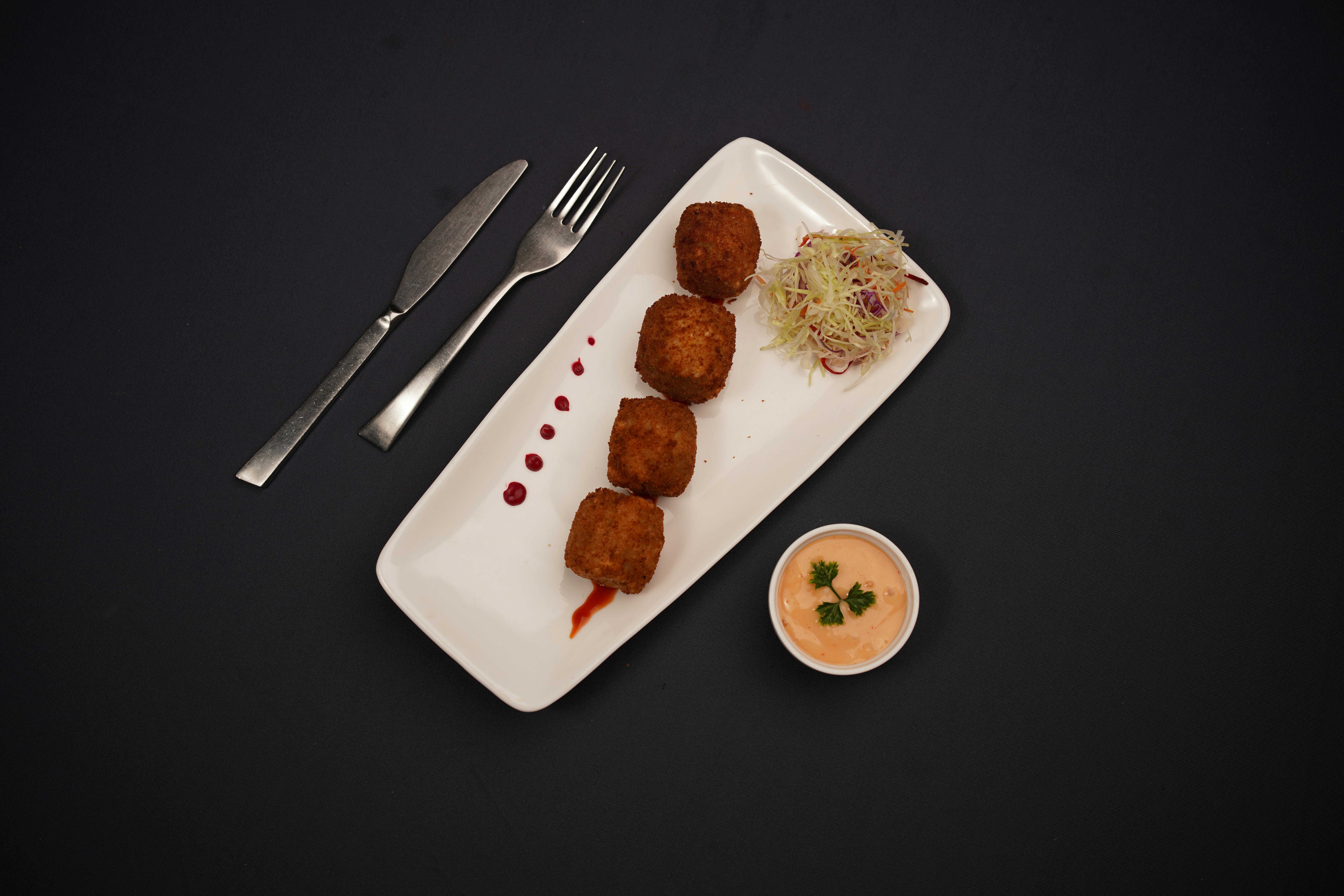 Top View of a Deep Fried Dish with Vegetables and Sauce · Free Stock Photo