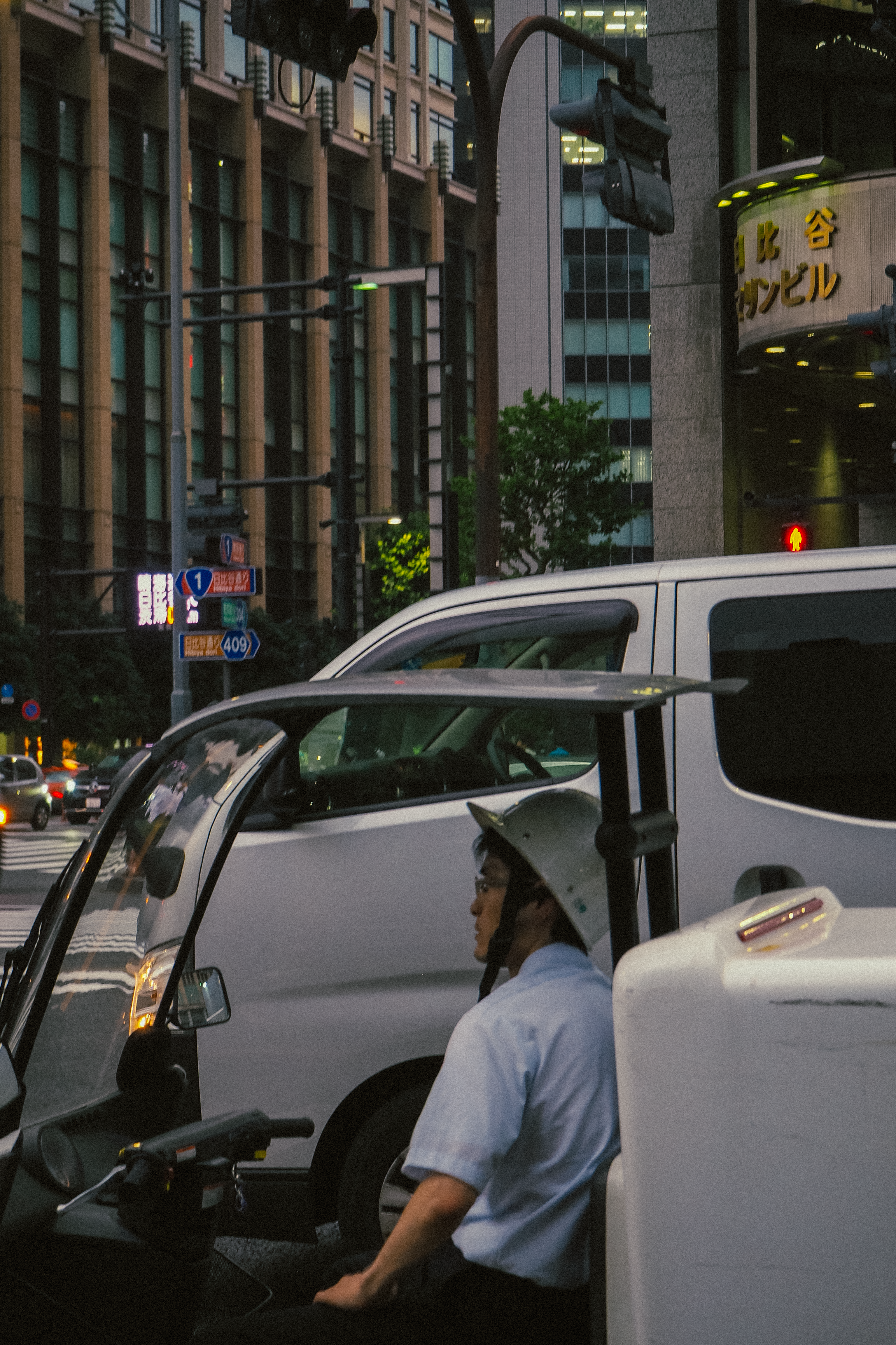 Asian Man Driving a Vehicle on a Busy Street of a City · Free Stock Photo