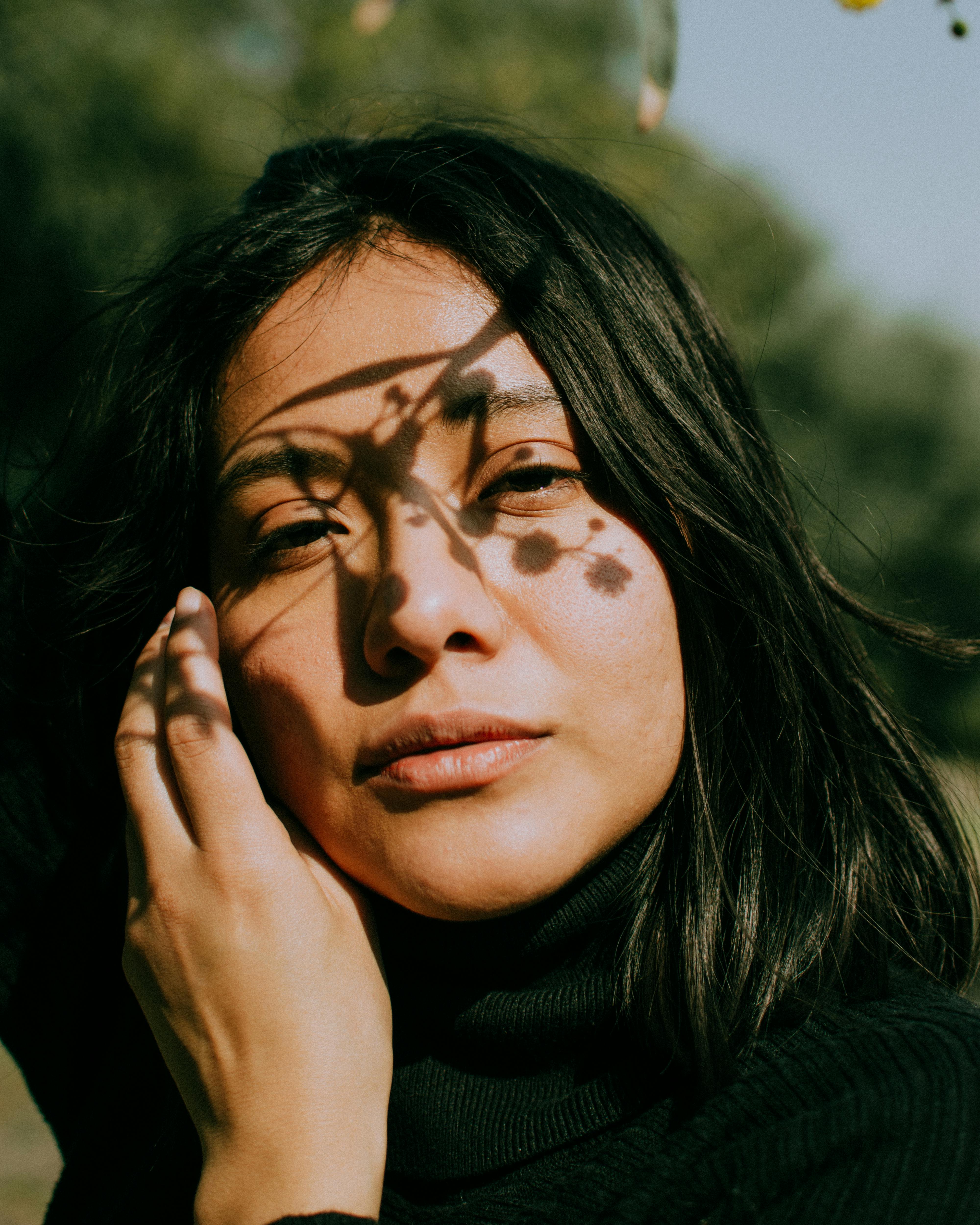 Woman in a Black Turtleneck with the Shadow of a Twig on Her Face ...