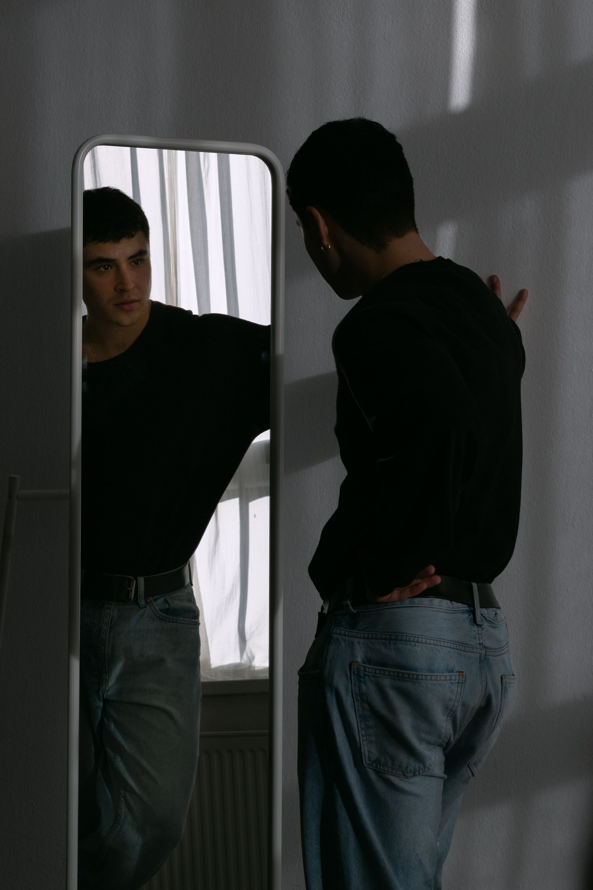 Young Man Standing in Front of a Mirror · Free Stock Photo
