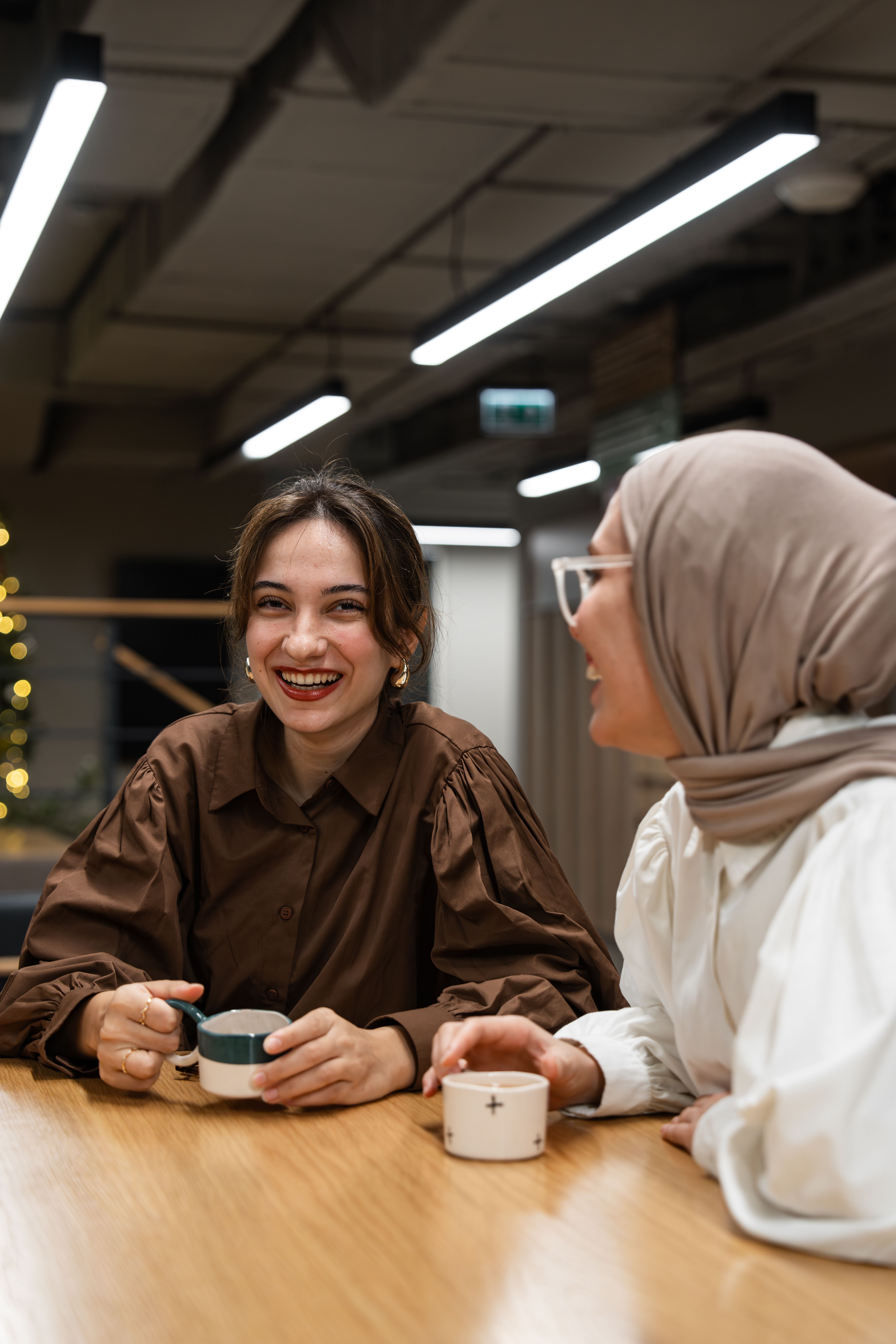 Two Women Talking At the Table · Free Stock Photo