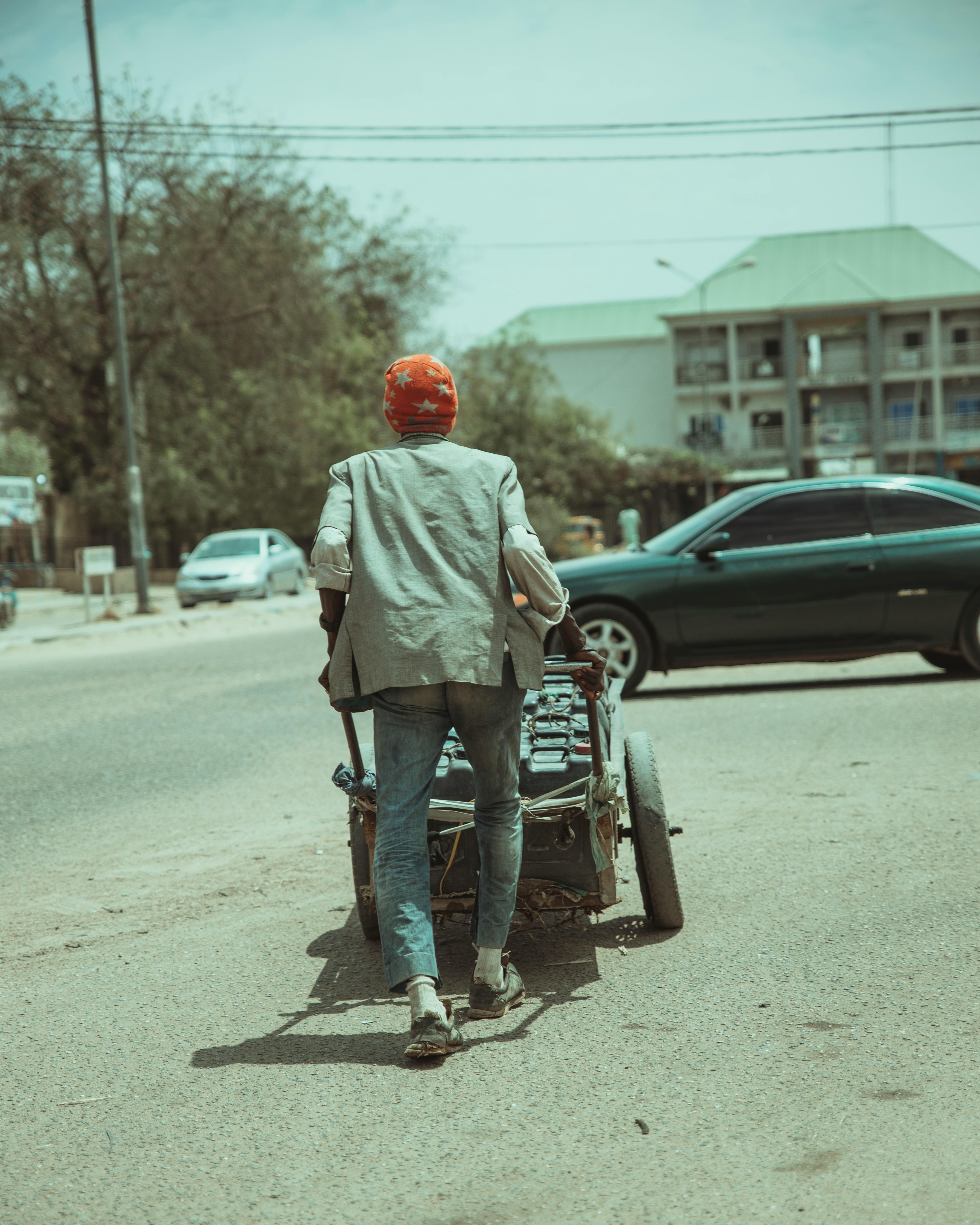 Man Pushing a Cart with Scrap · Free Stock Photo