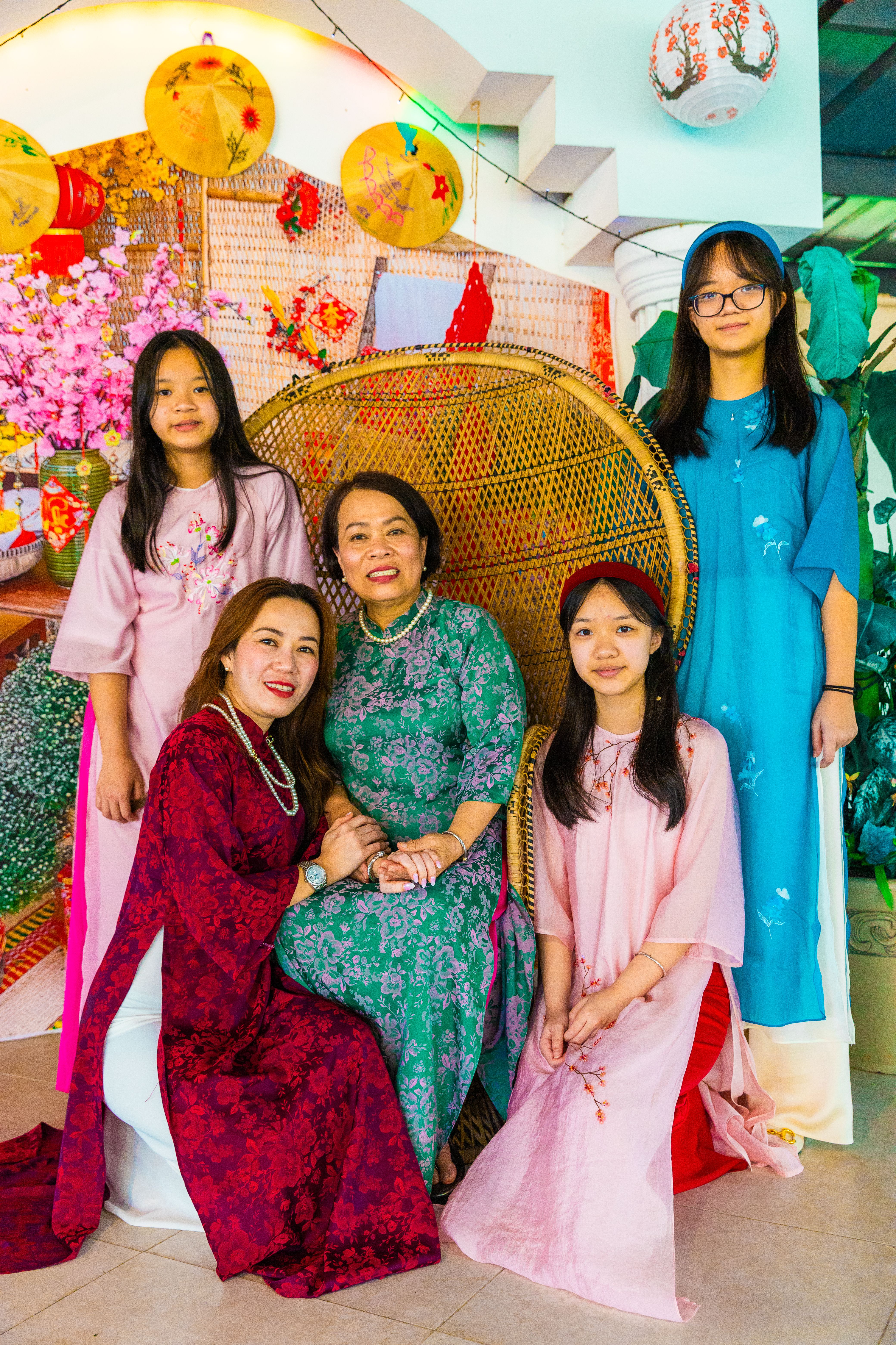 Smiling Women and Girls Sitting in Traditional Clothing · Free Stock Photo