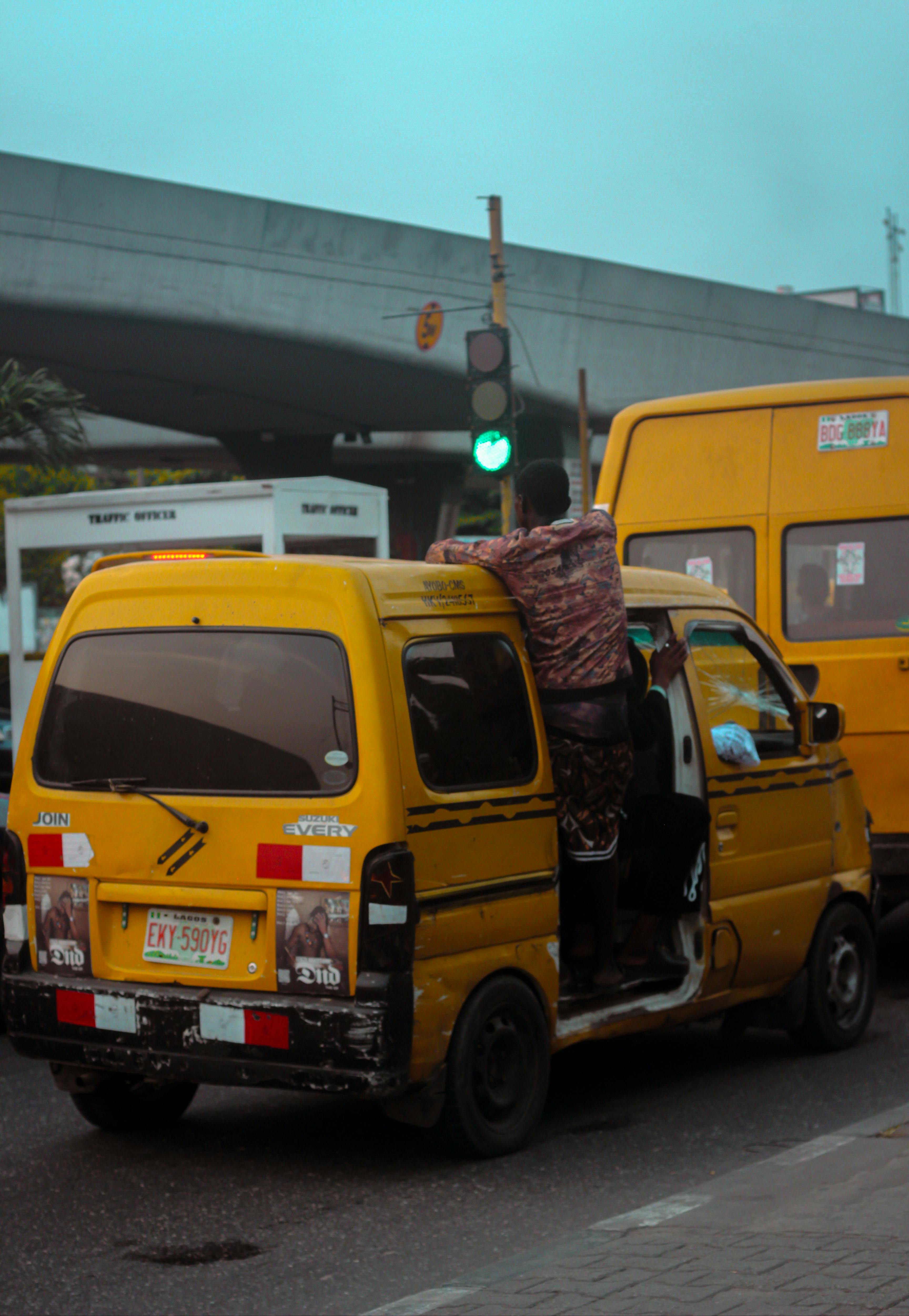 Man Standing on Yellow Van · Free Stock Photo