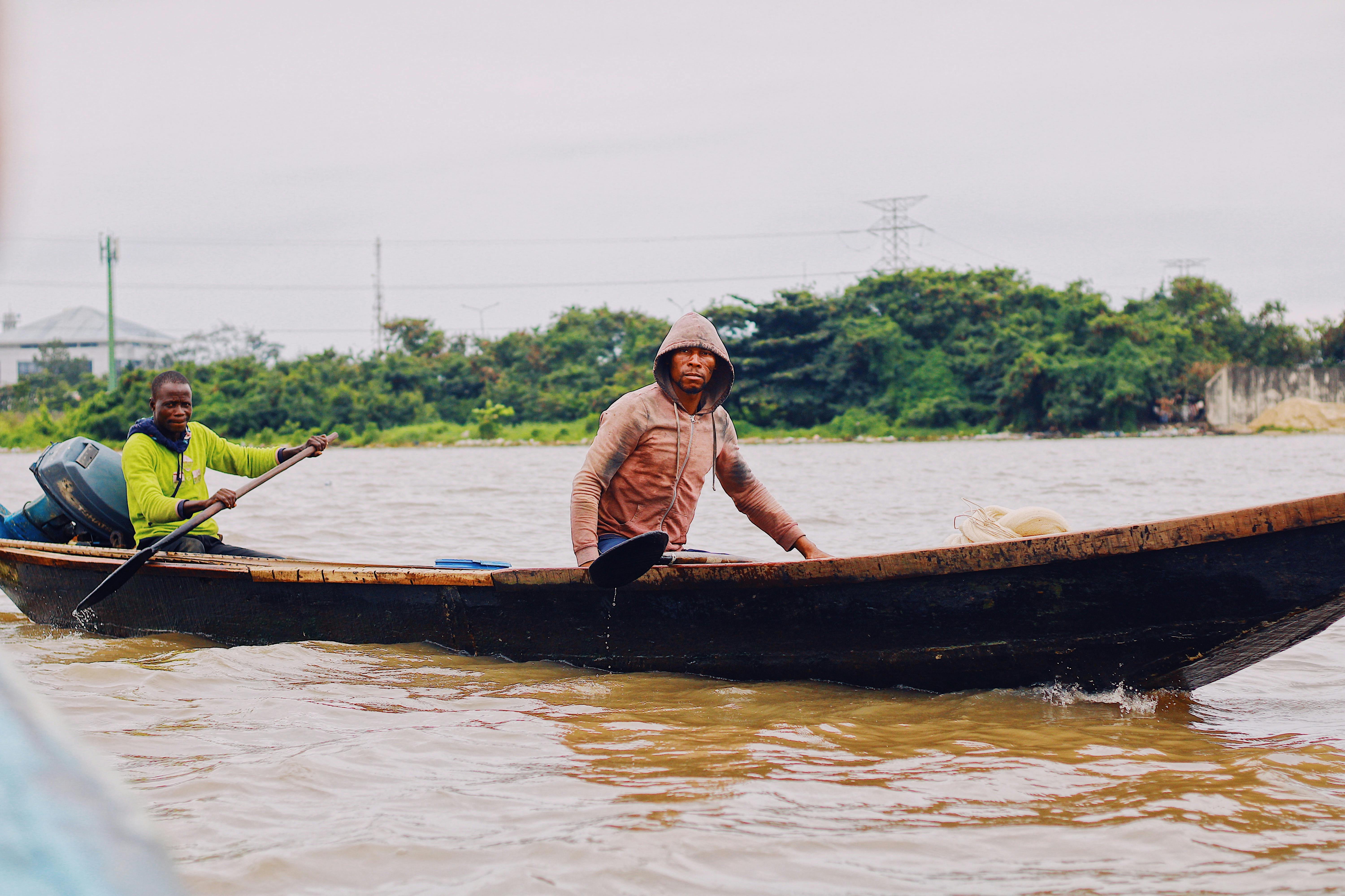 Fishermen Rowing on the River · Free Stock Photo