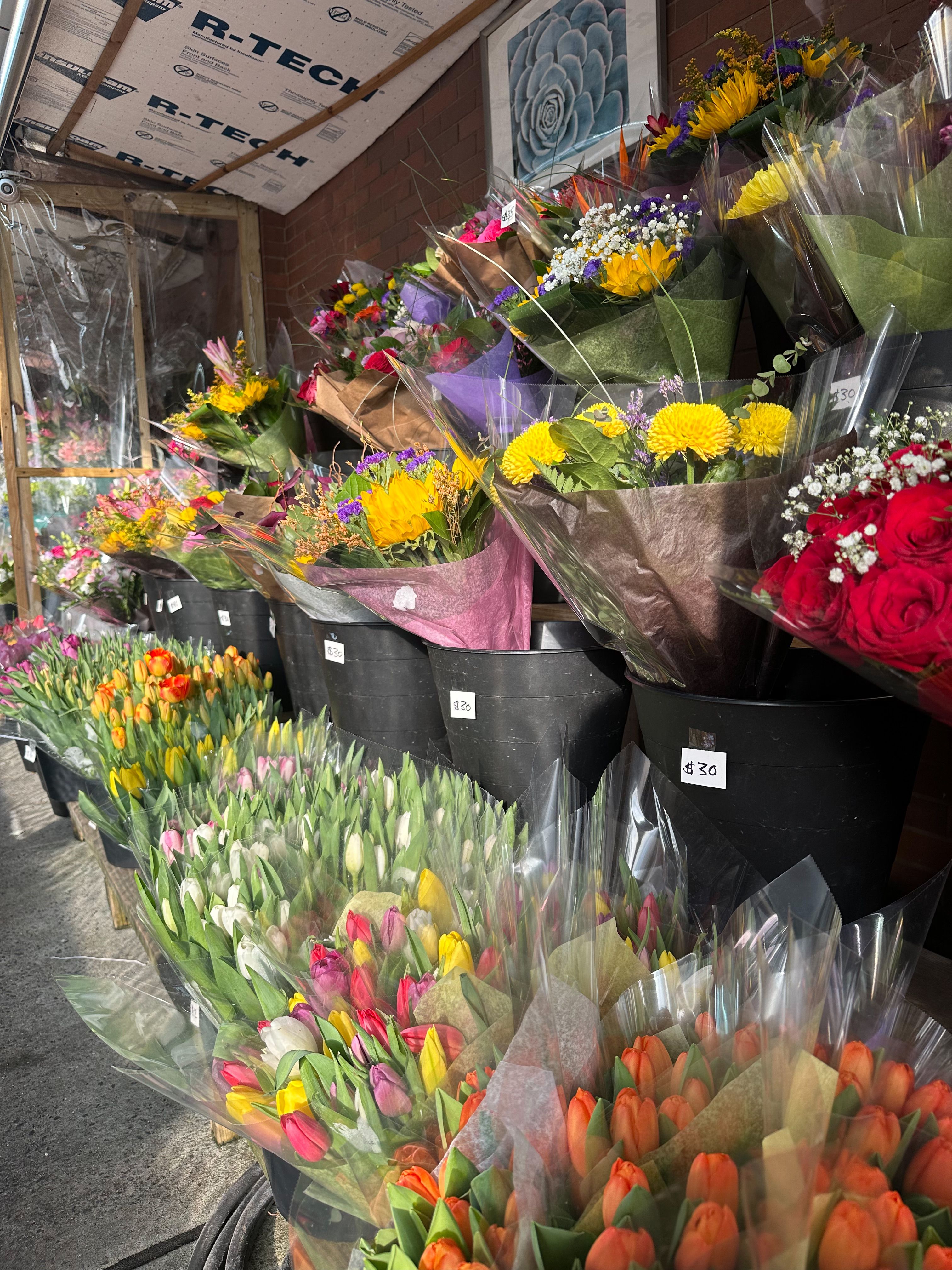 Pre-made Flower Bouquets on Display at the Market Stall · Free Stock Photo