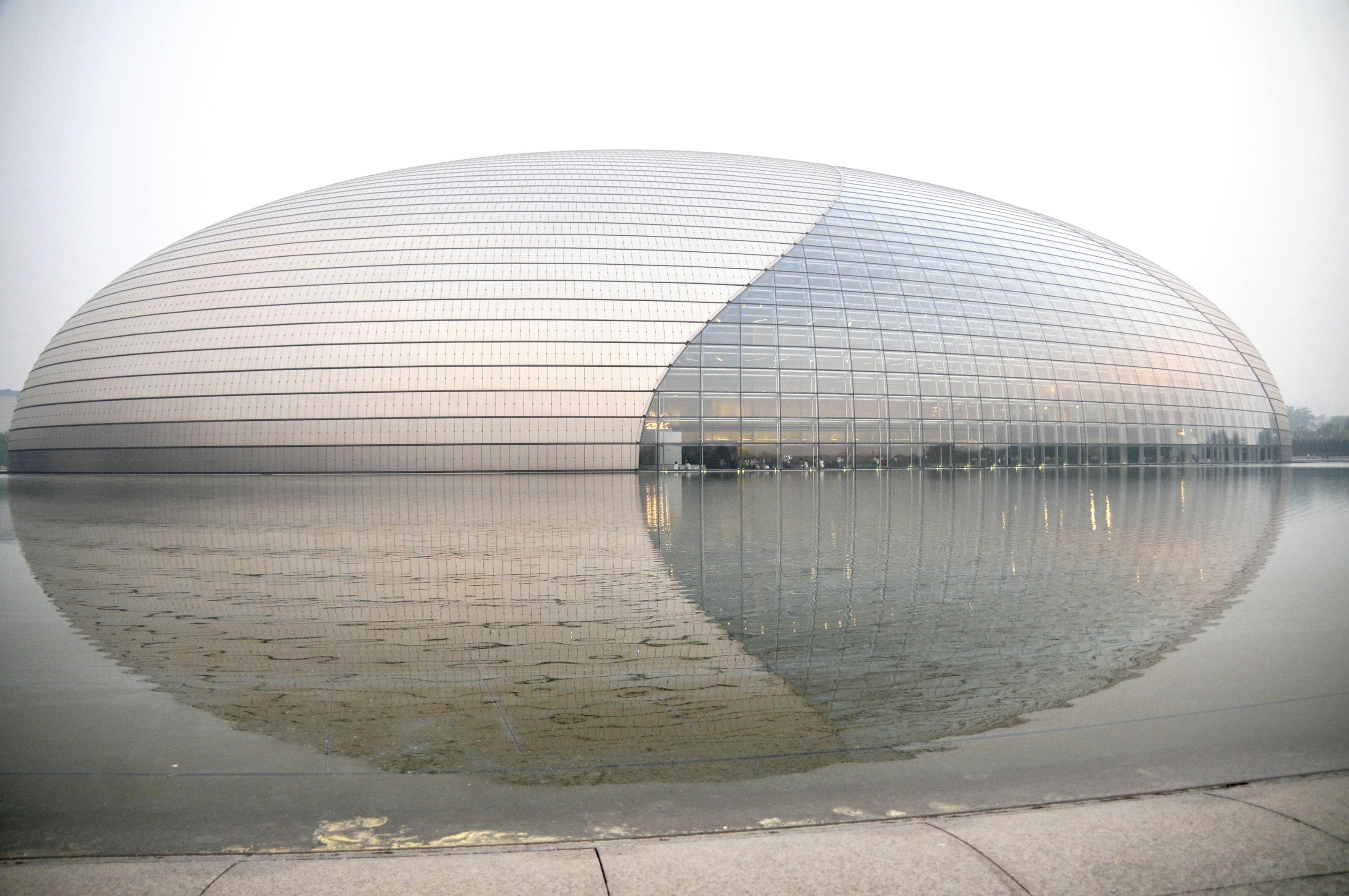 Contemporary Oval Building with its Reflection in the Water around It ...