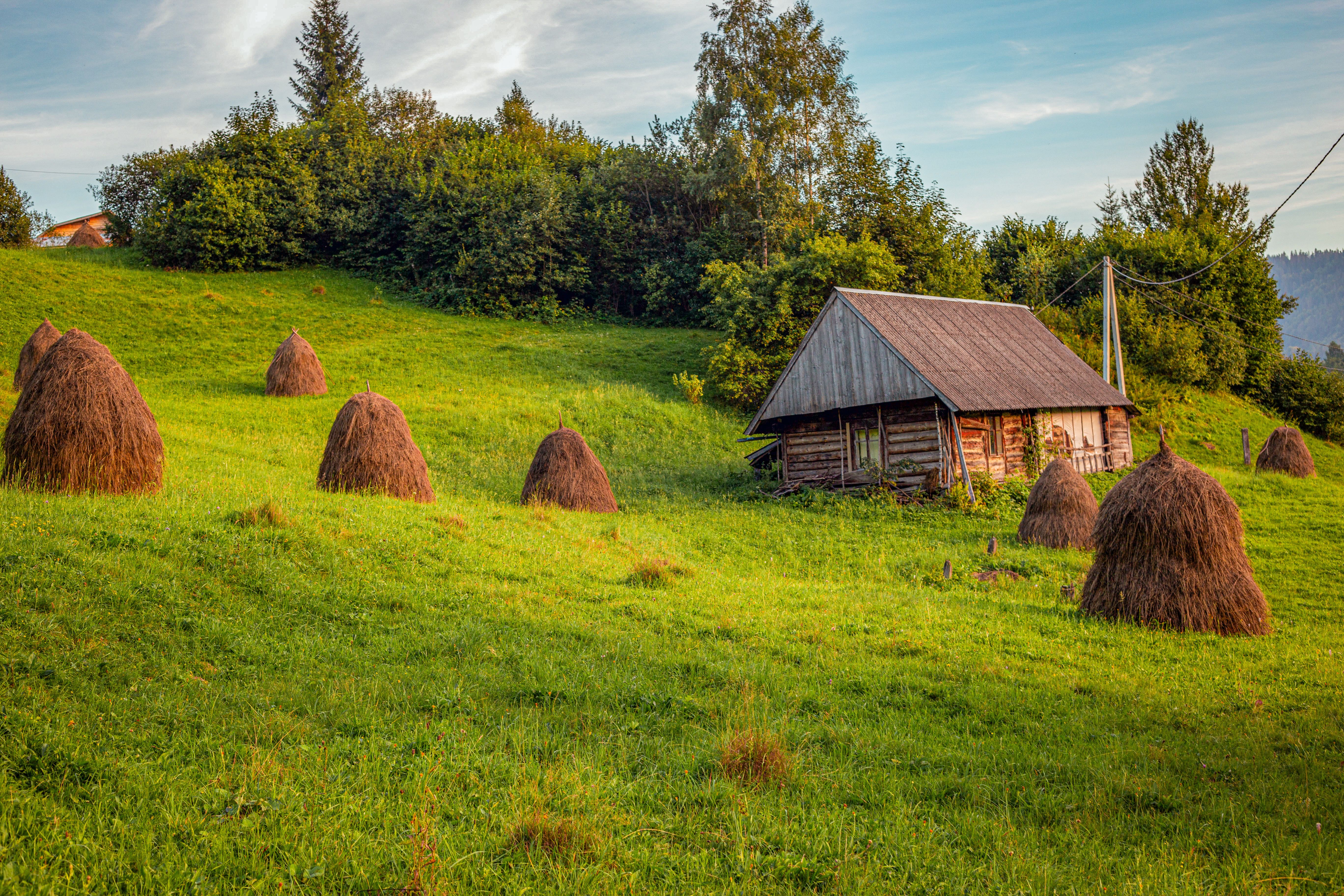 Hay Bales around Wooden House in Countryside · Free Stock Photo
