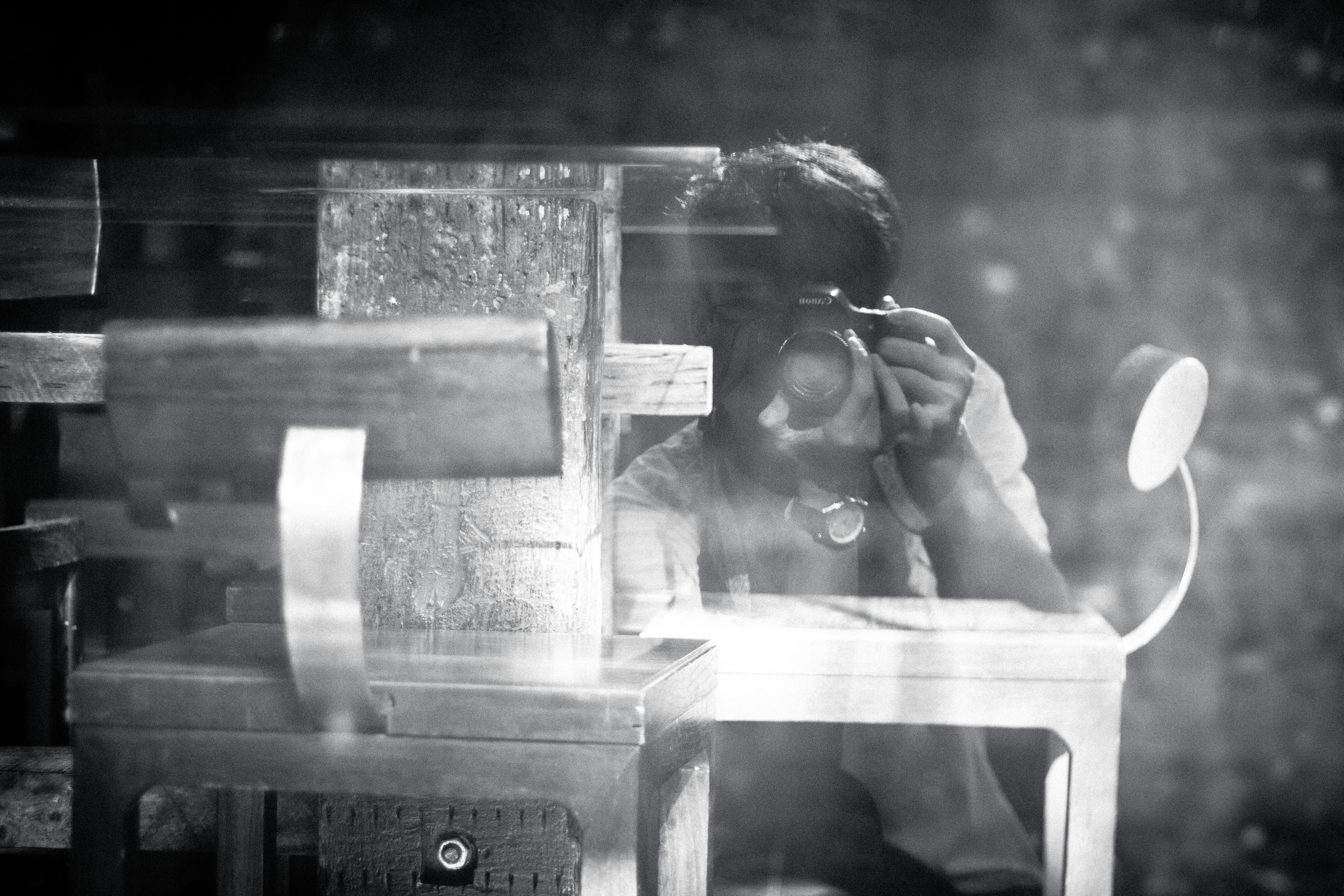 Man Sitting with Camera behind Window and Taking Pictures · Free Stock ...