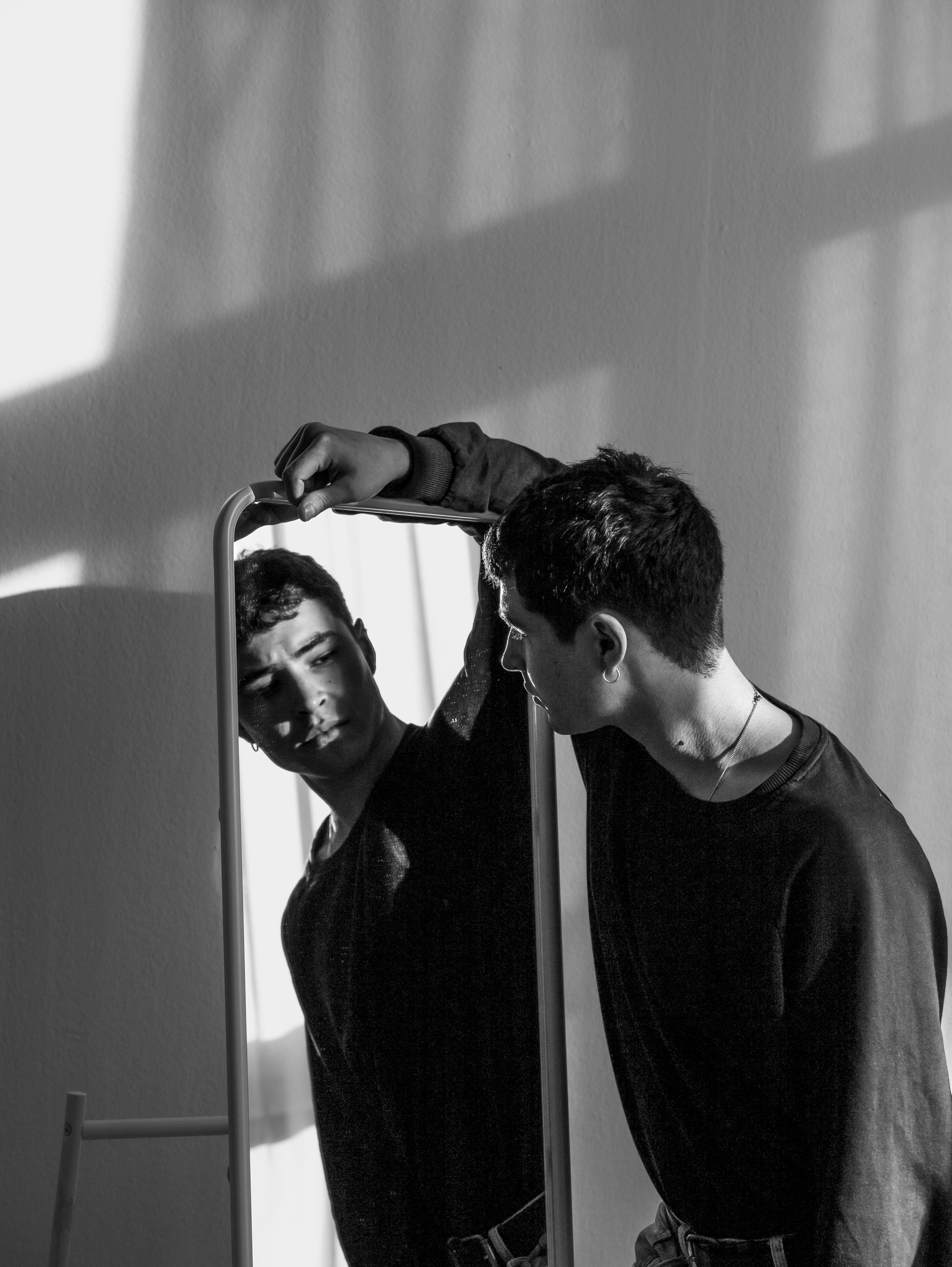 Man Standing by Mirror in Black and White · Free Stock Photo
