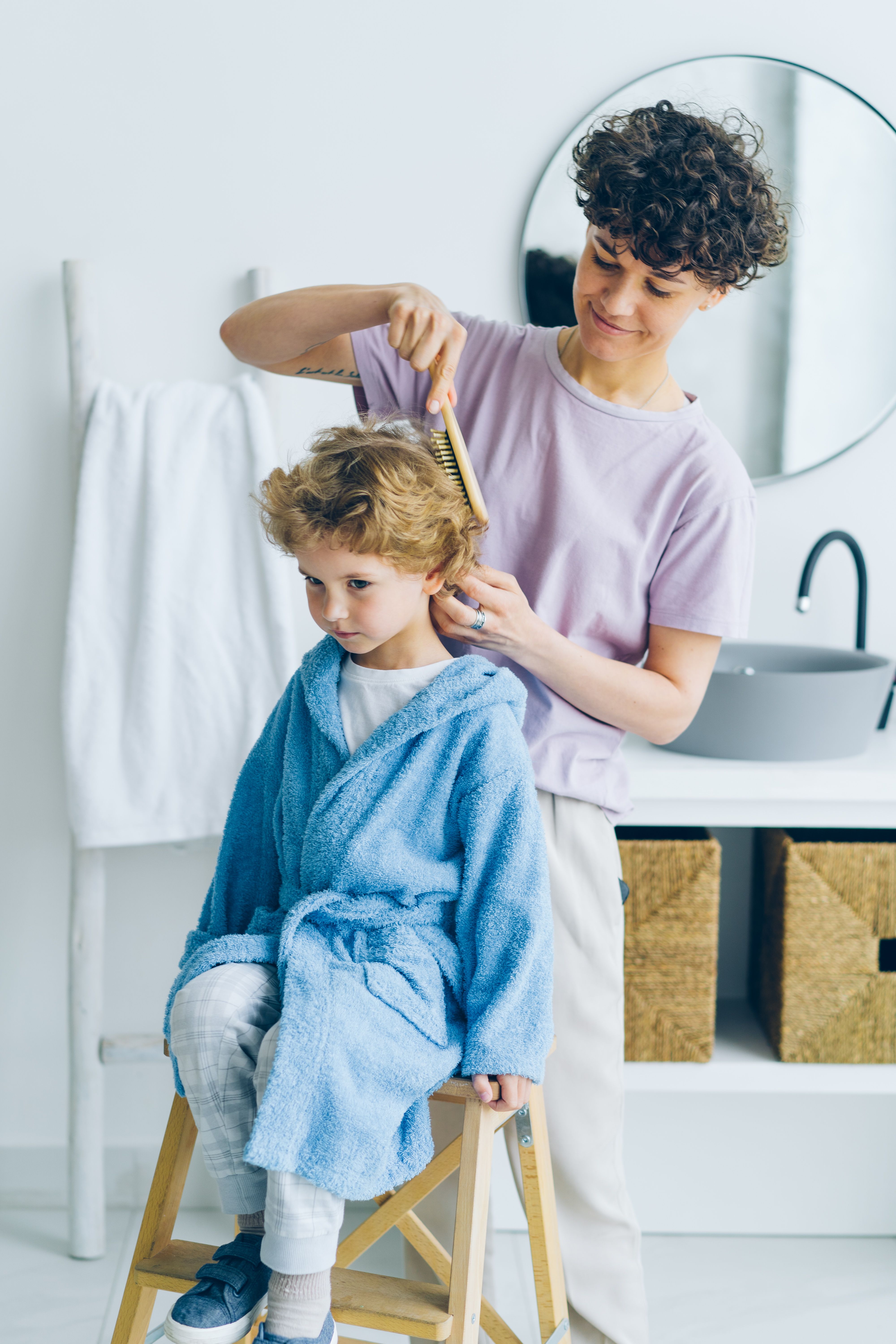Smiling Mother Combing Son Hair · Free Stock Photo
