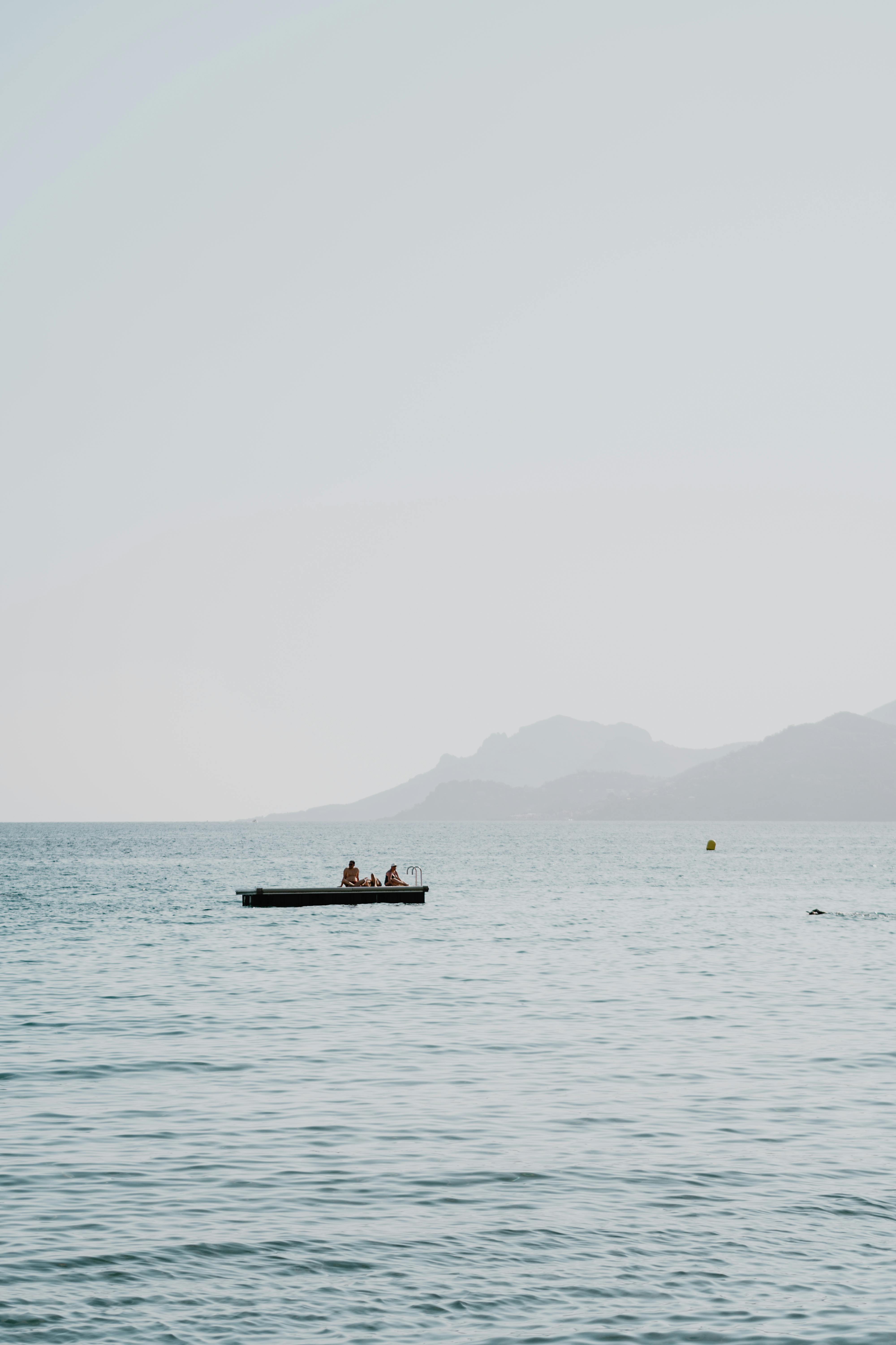 Men on Canoe on Calm Sea · Free Stock Photo