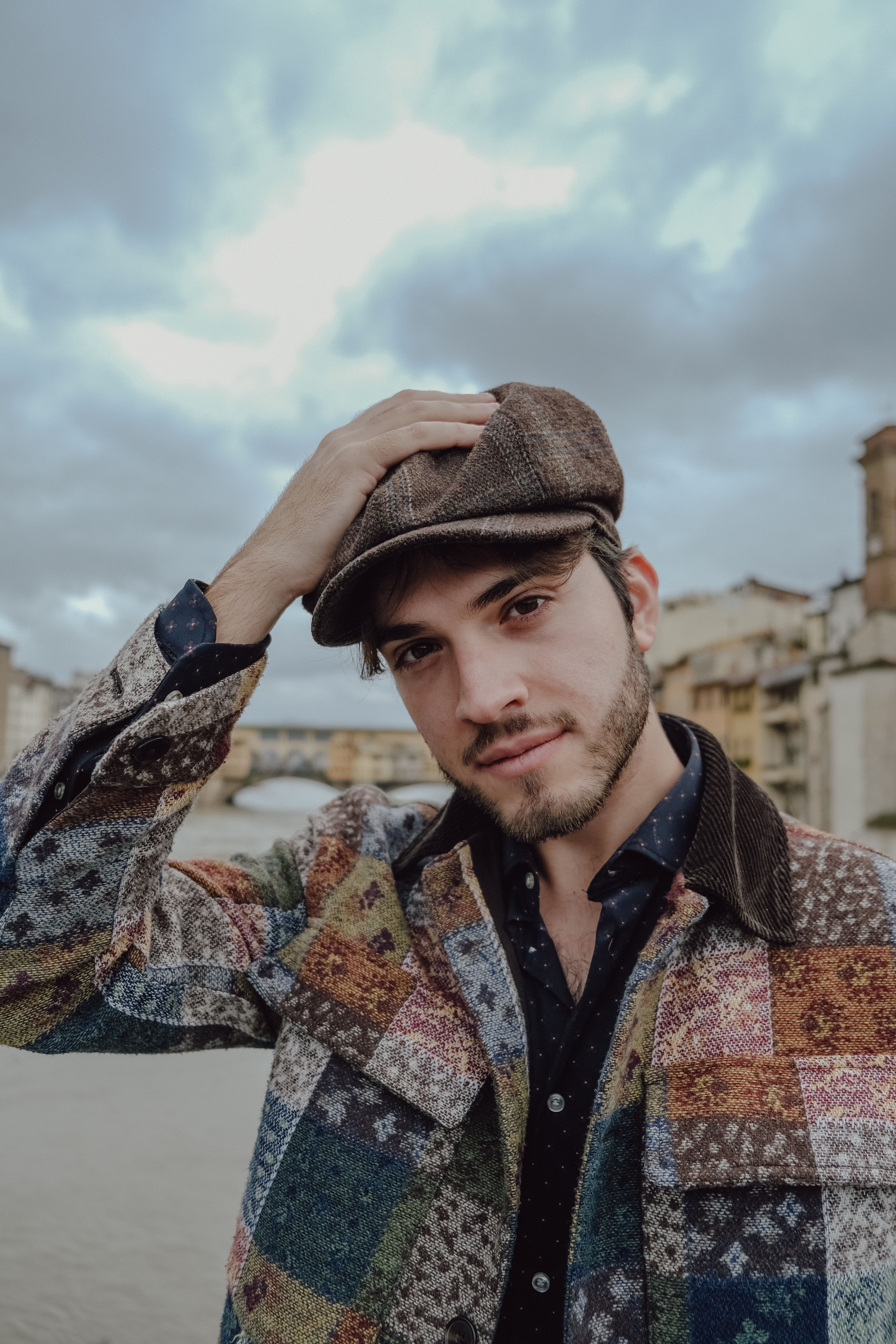 Portrait of Man in Jacket Standing with Arm Raised · Free Stock Photo