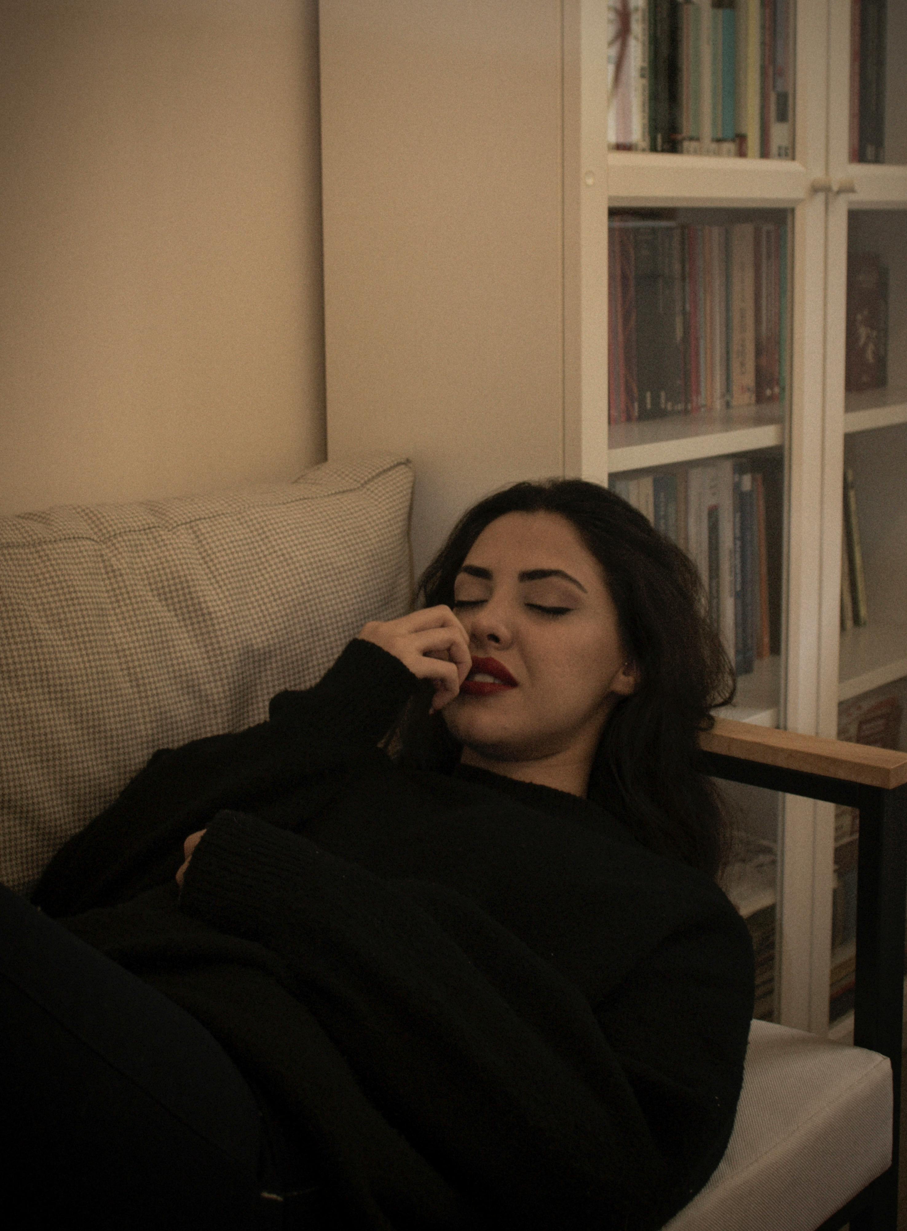 Woman Sitting Next to Table and Right Hand on Ear · Free Stock Photo