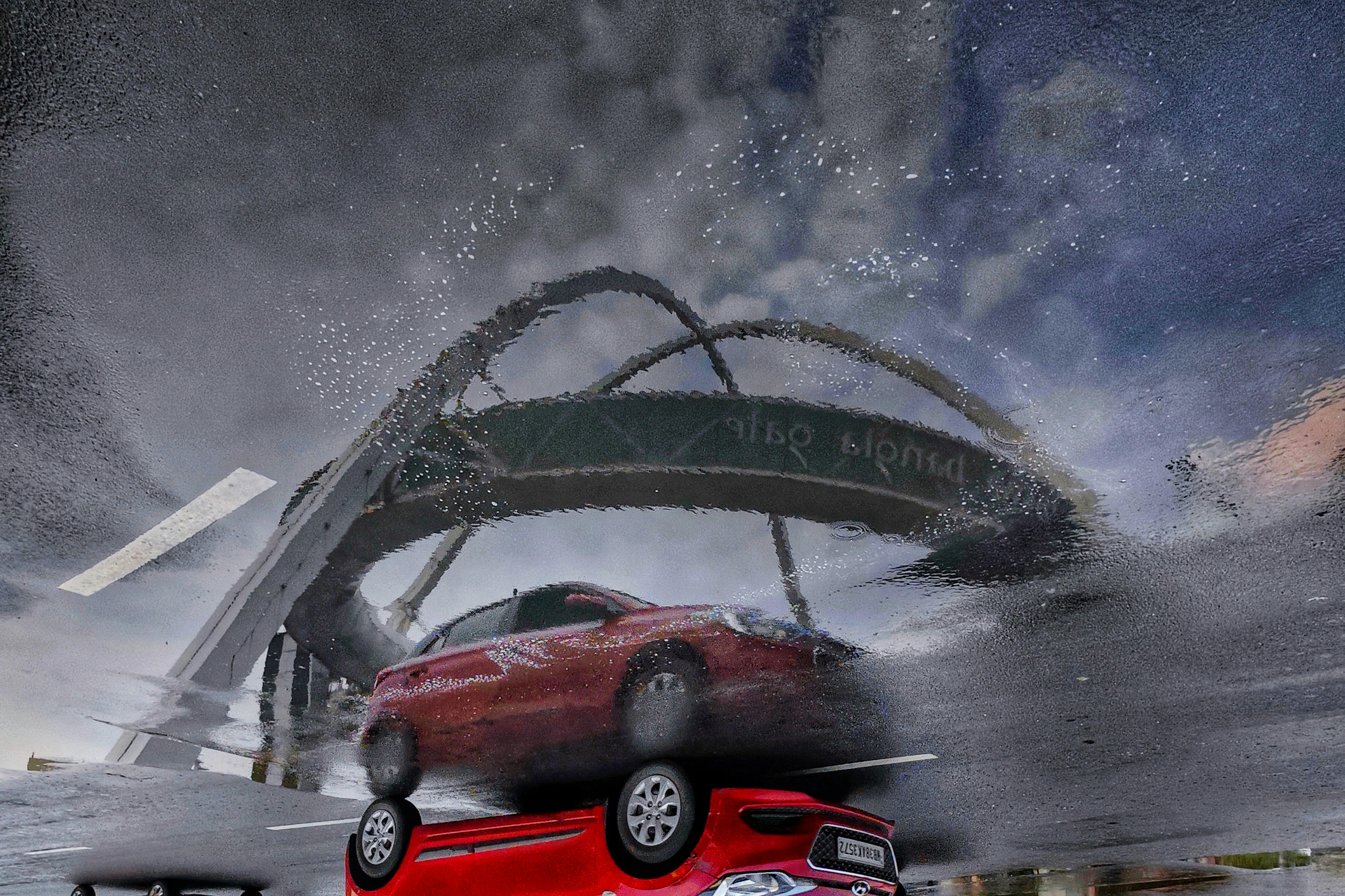 Reflection of a Red Car and a Built Struture, in a Puddle · Free Stock ...